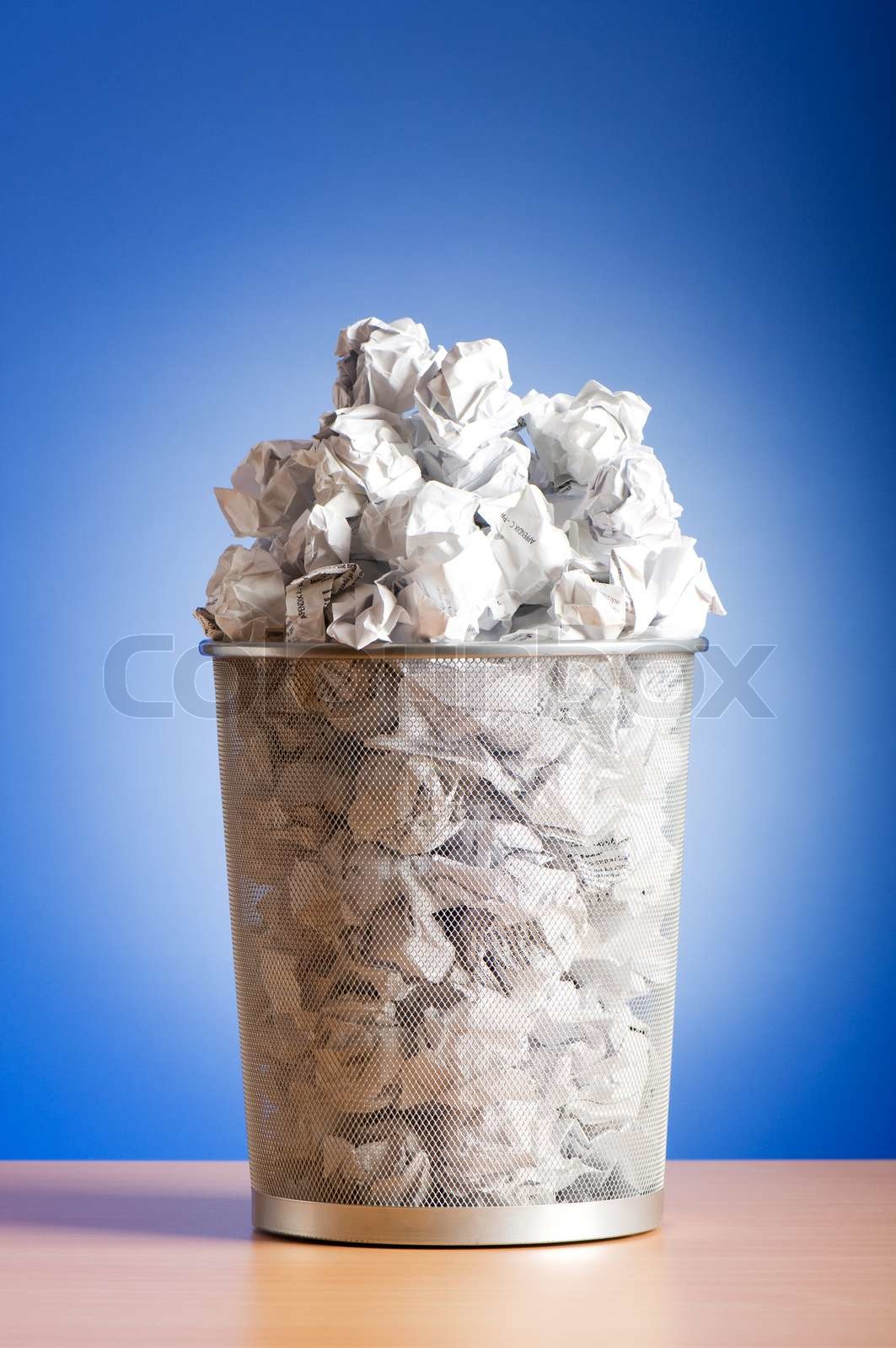 Garbage bin with paper waste isolated on white | Stock image | Colourbox