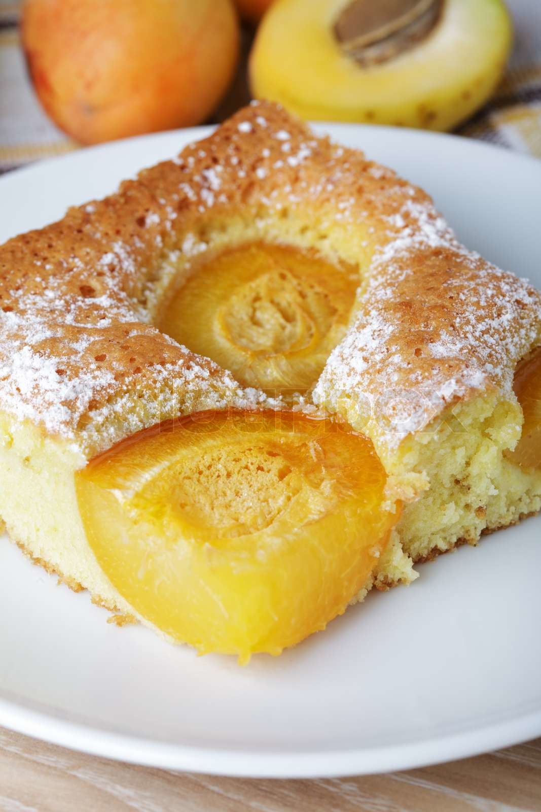 Slices of fresh apricot iced sponge cake with fruits | Stock image ...