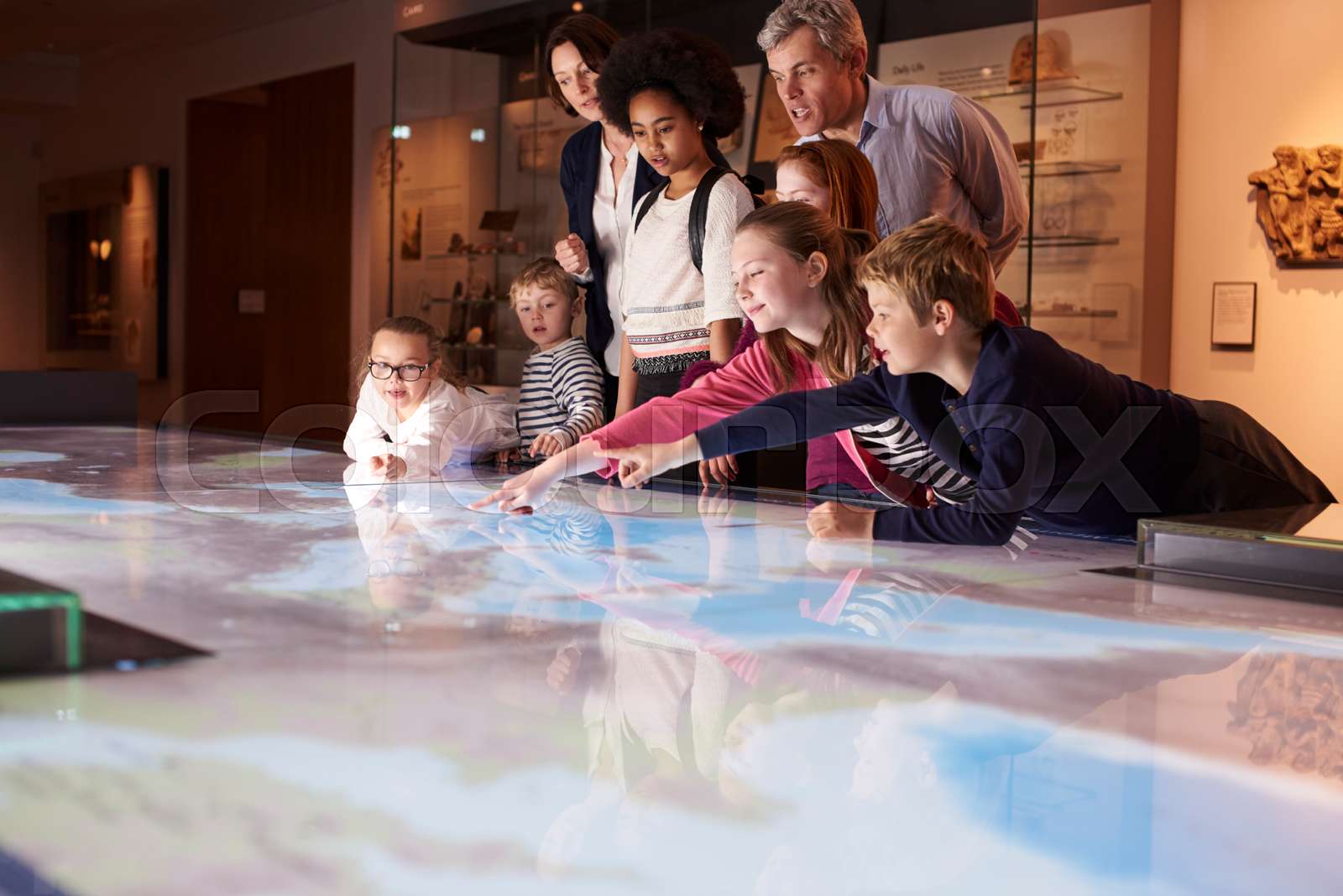 Pupils On School Field Trip To Museum Looking At Map | Stock image ...