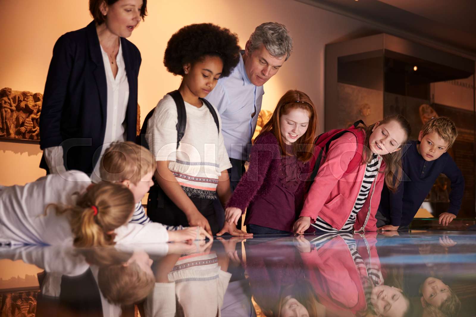 Pupils On School Field Trip To Museum Looking At Map | Stock image ...