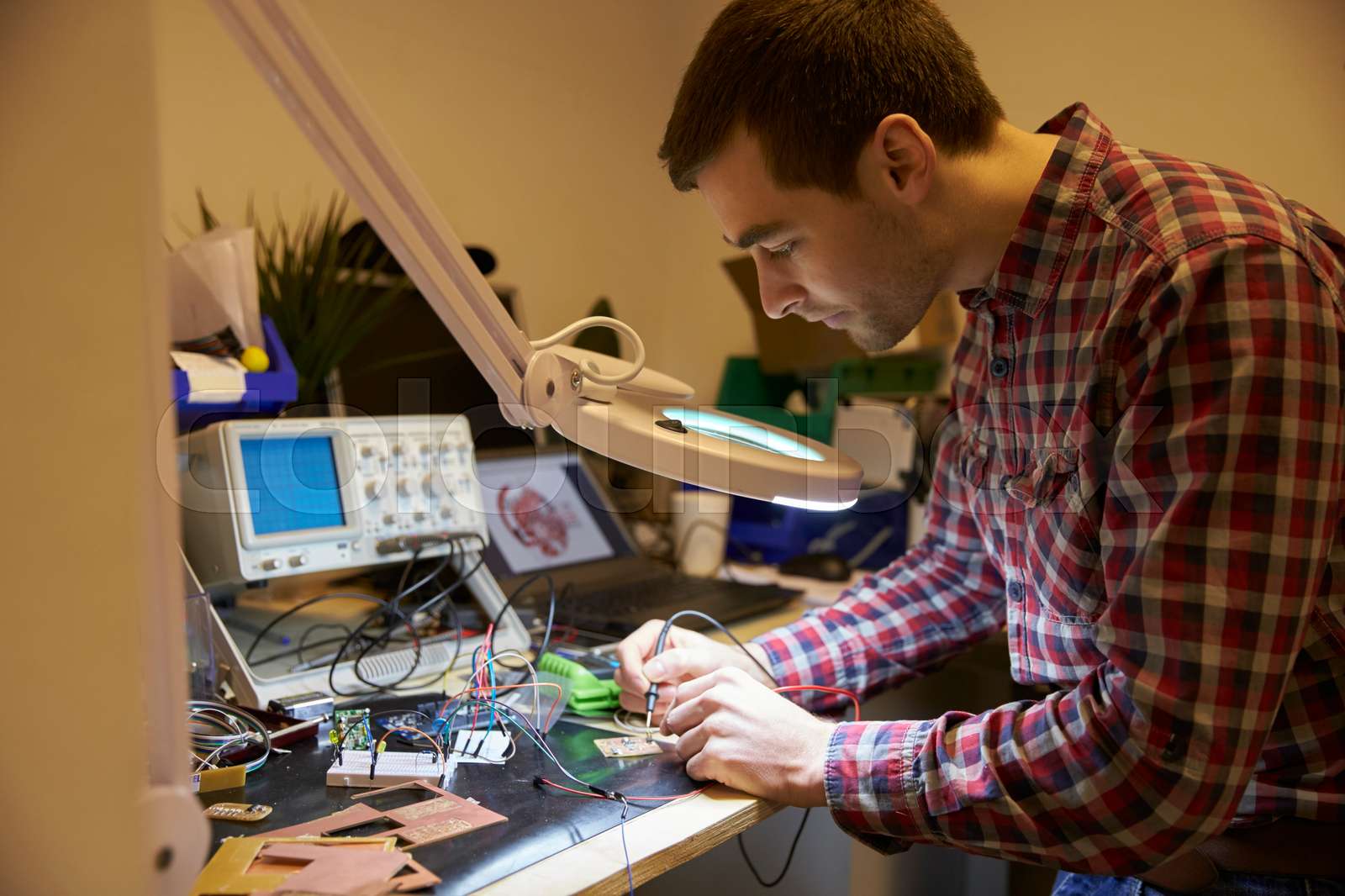 Electrical Engineer Soldering Circuit Board At Work Bench | Stock image ...