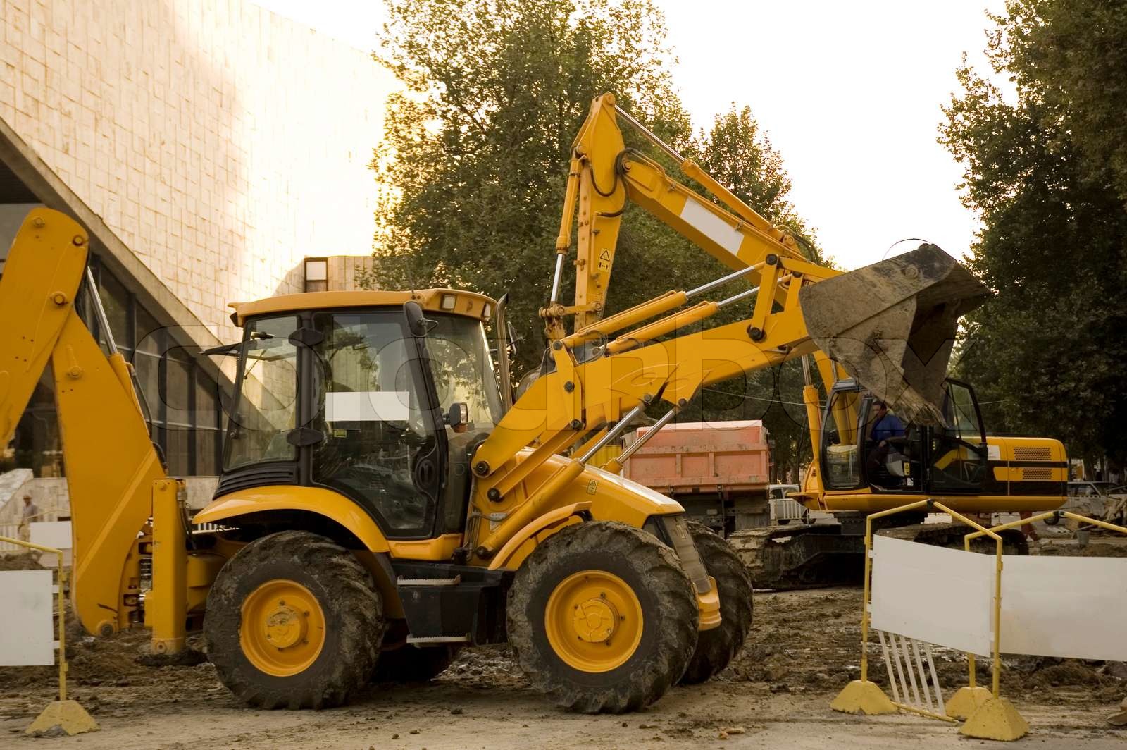 Construction vehicles on the site digging a trench | Stock image ...