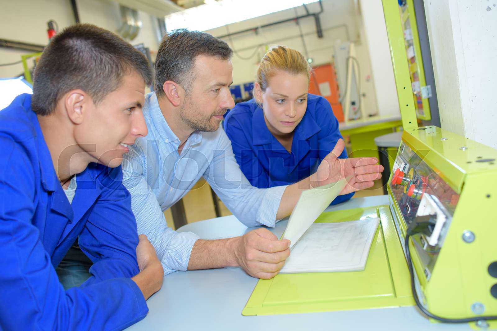 People looking at technical machine | Stock image | Colourbox