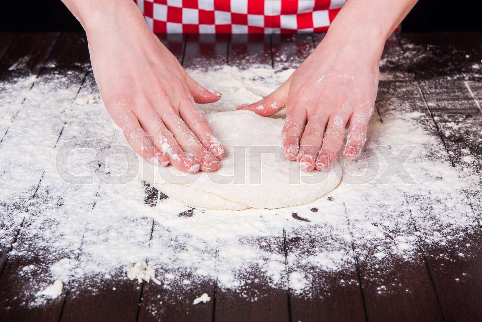 Cook preparing dough for baking in the kitchen | Stock image | Colourbox