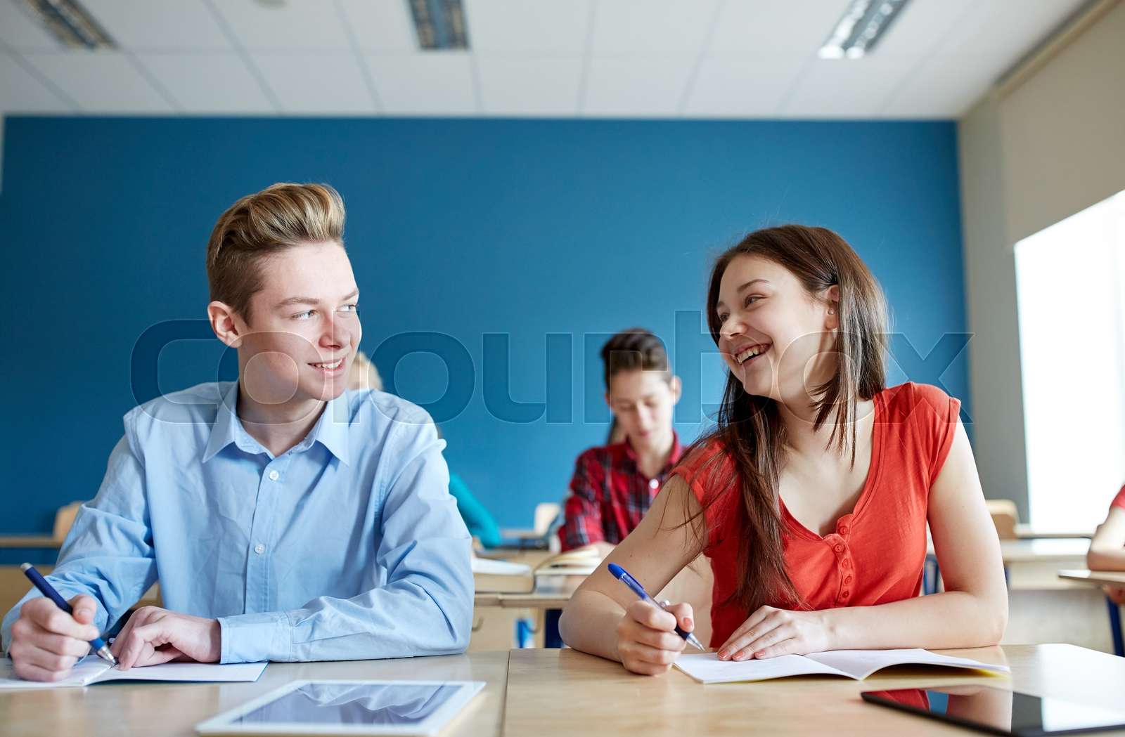 group of happy students talking at school lesson | Stock image | Colourbox
