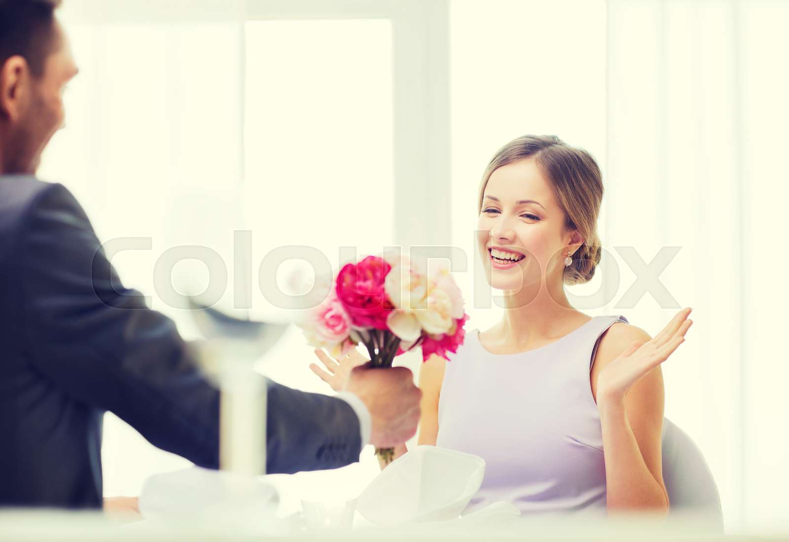 amazed woman recieving bouquet of flowers | Stock image | Colourbox