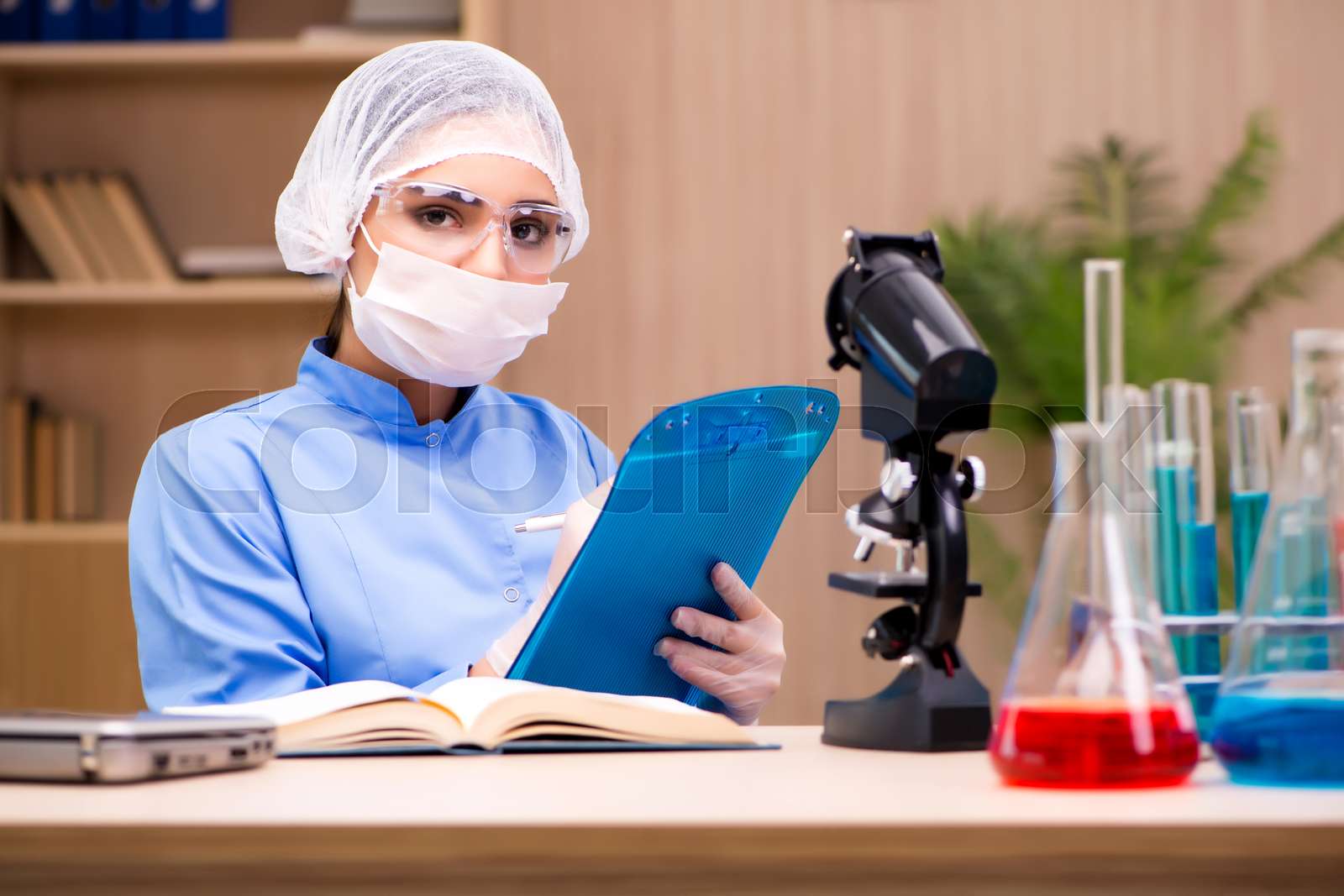 Lab chemist working with microscope and tubes | Stock image | Colourbox