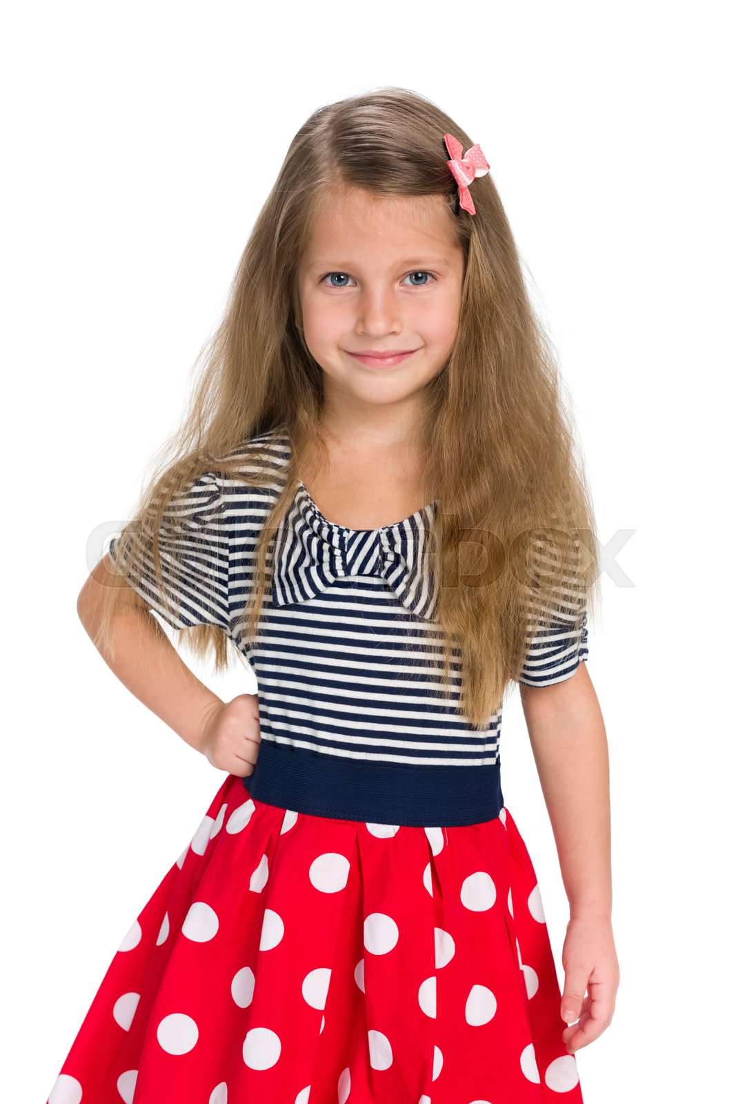 Smiling small girl stands | Stock image | Colourbox