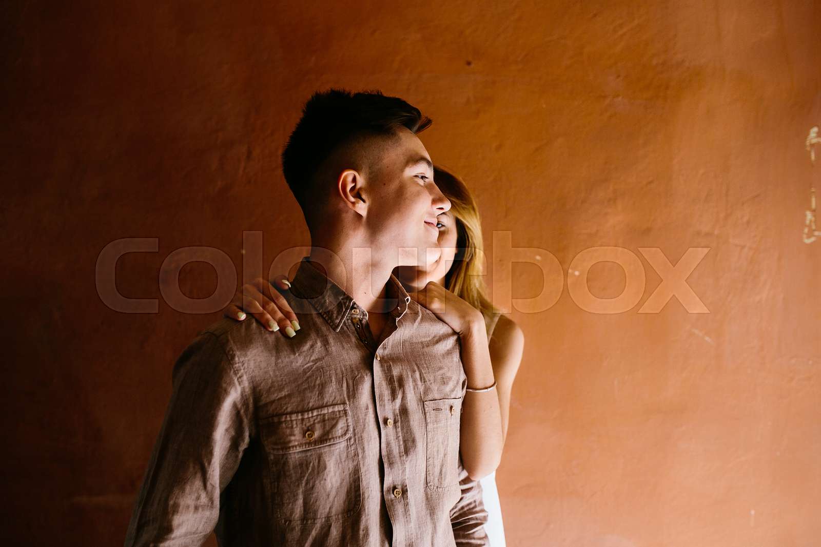 girl hugging guy from behind | Stock image | Colourbox