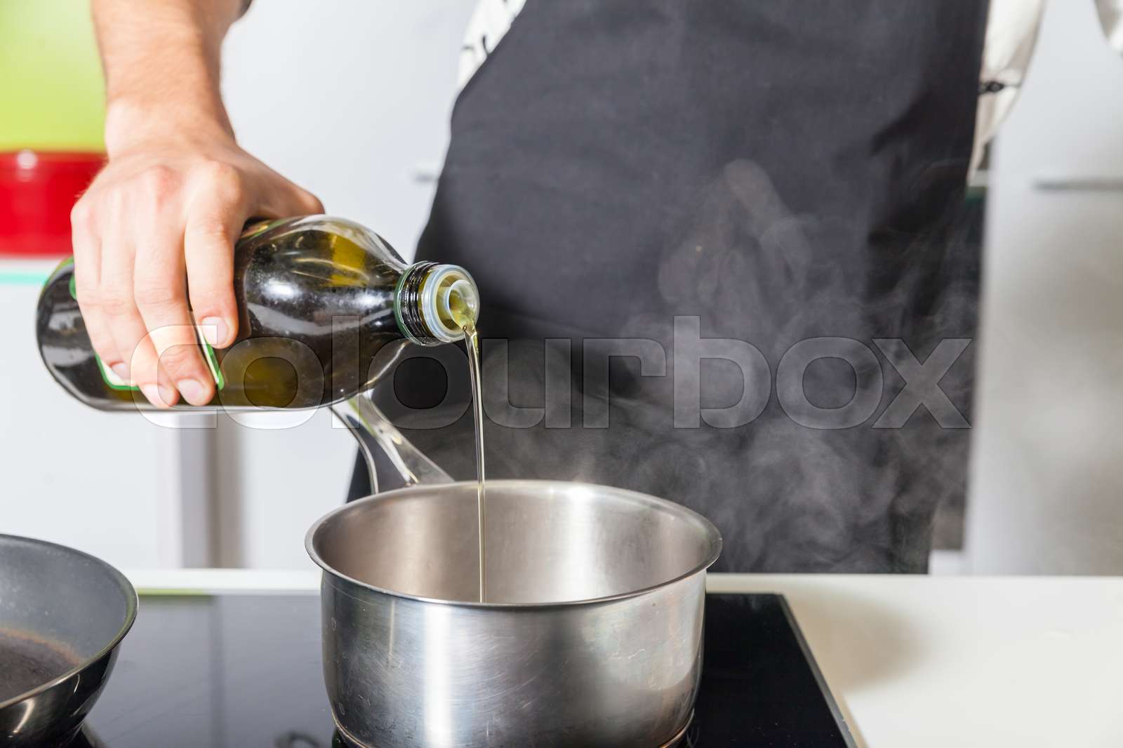 Man pouring oil | Stock image | Colourbox