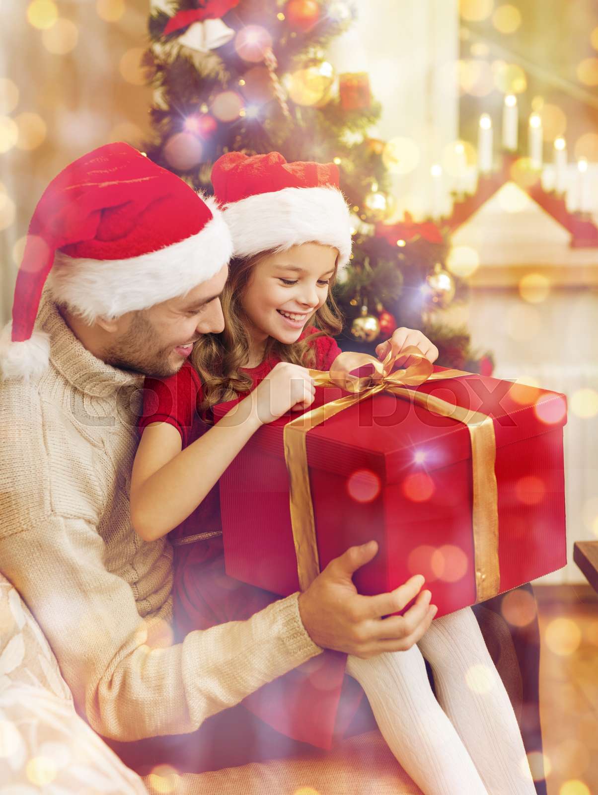 smiling father and daughter opening gift box | Stock image | Colourbox