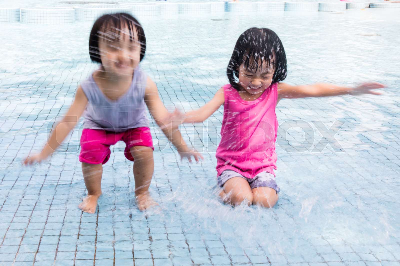 Asian Chinese Little Girls Splashing at the pool | Stock image | Colourbox