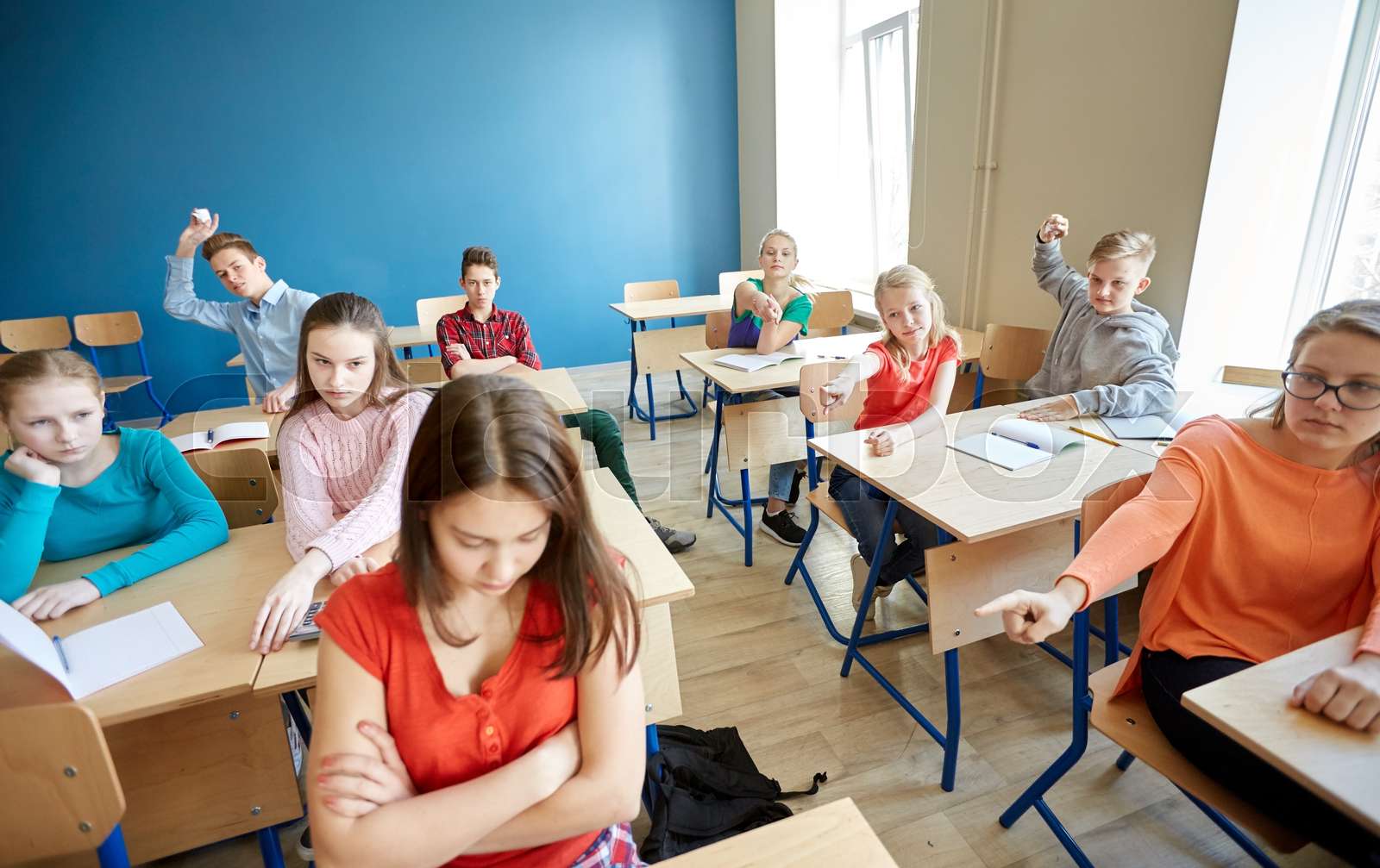 students gossiping behind classmate back at school | Stock image ...