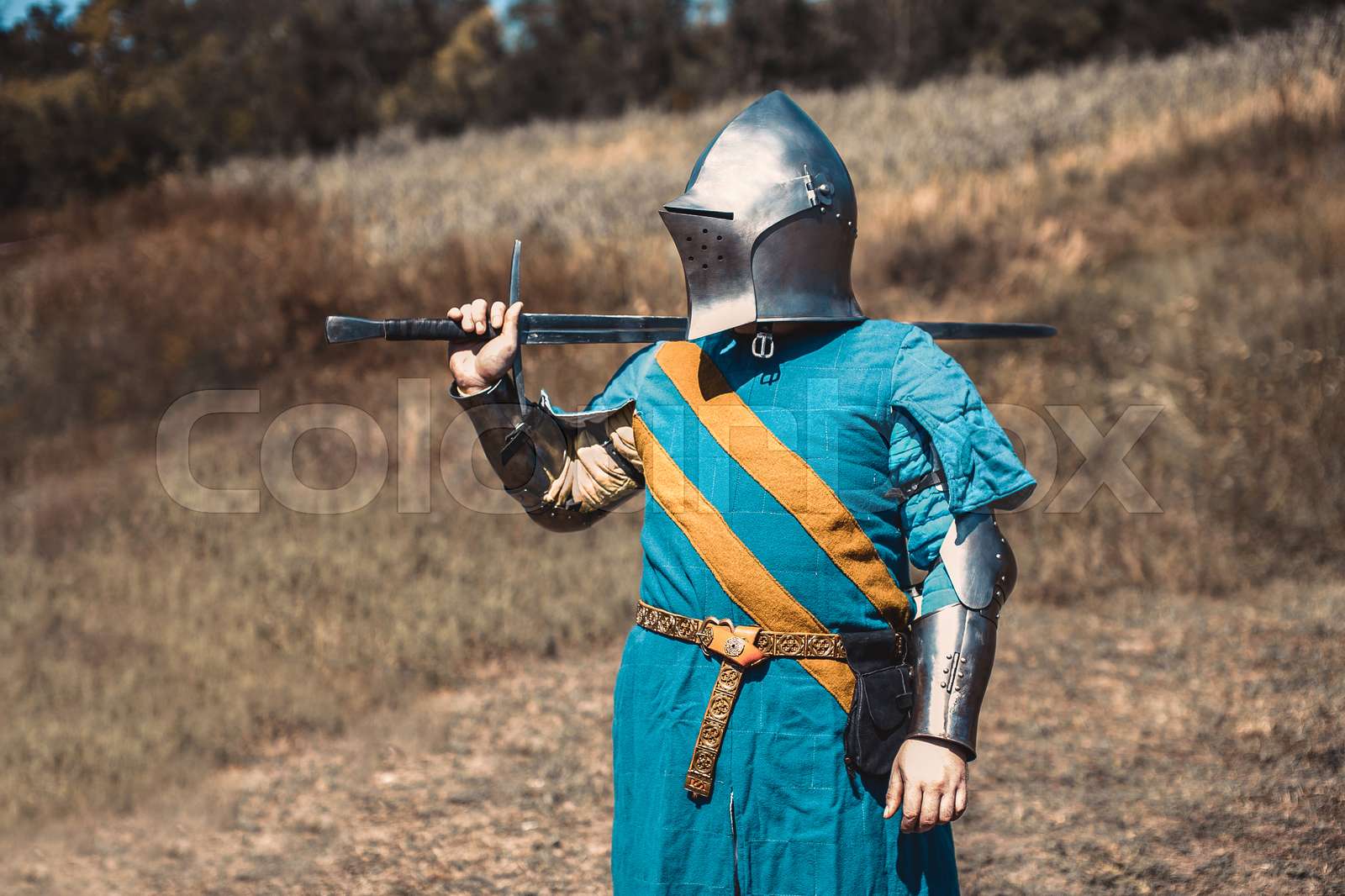 The knight in armor standing holding a sword in hand. | Stock image ...