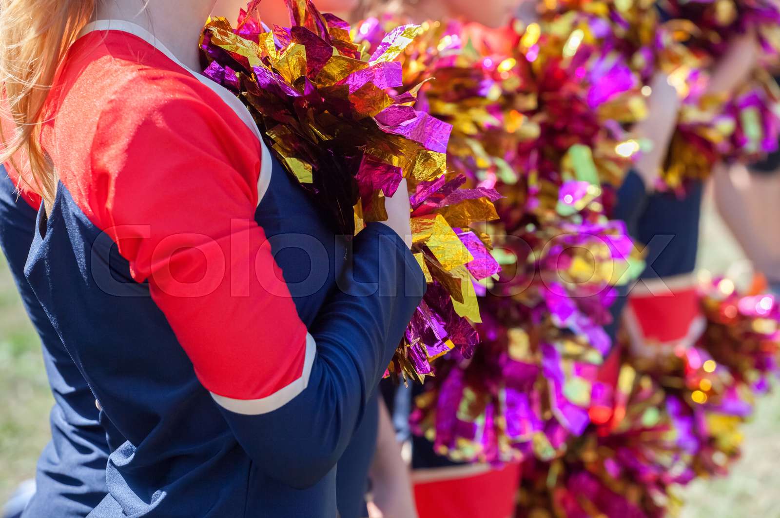 Cheerleaders holding pom-poms in their hands. | Stock image | Colourbox