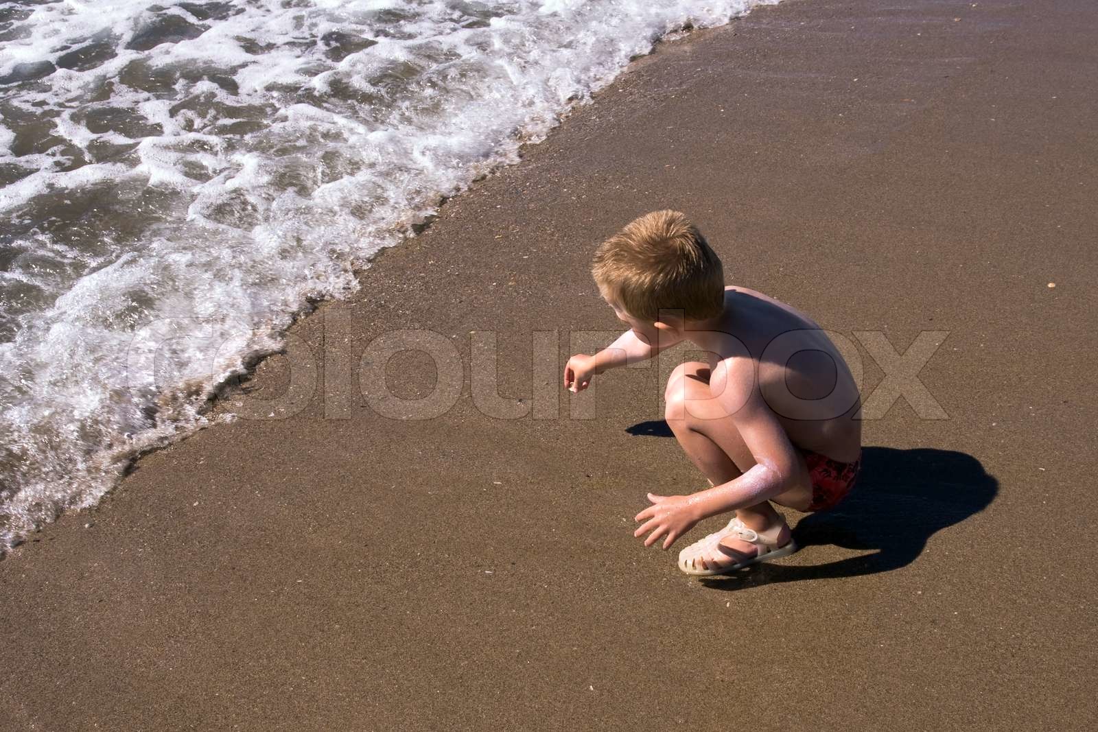 Ein kleines Kind beim Spielen am Strand | Stock Bild | Colourbox
