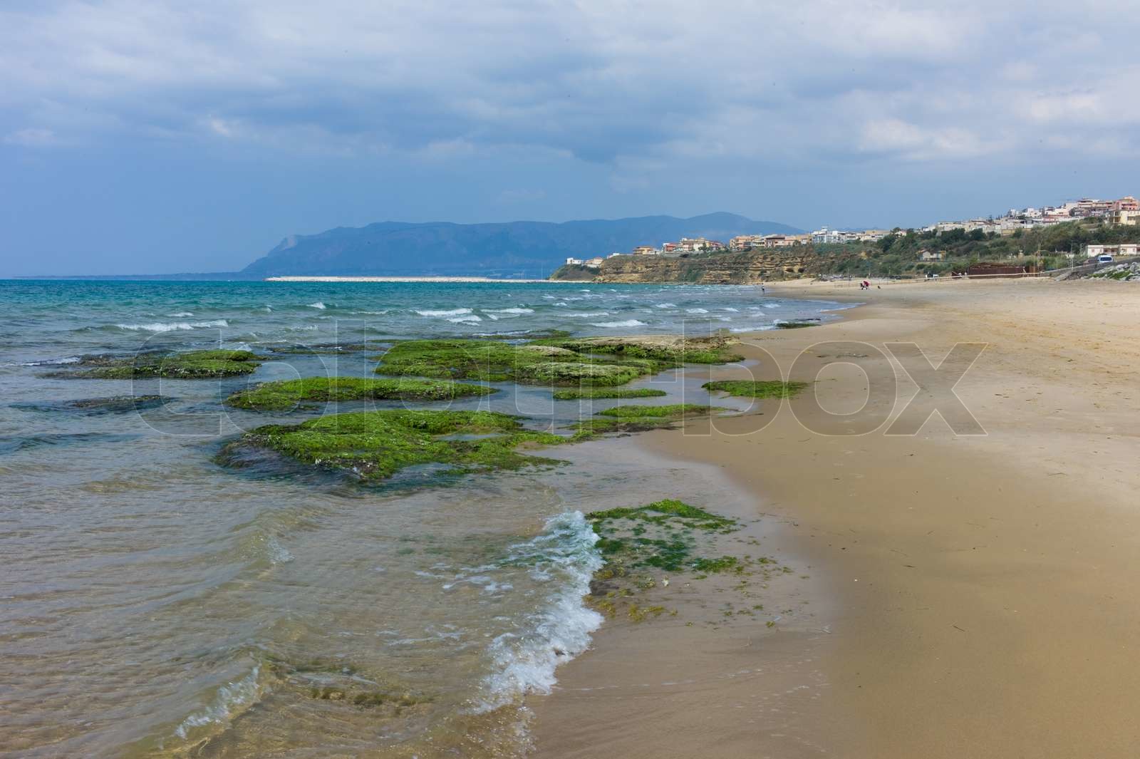 Sea and beach and algae with view to Balestrate, Sicily | Stock image ...