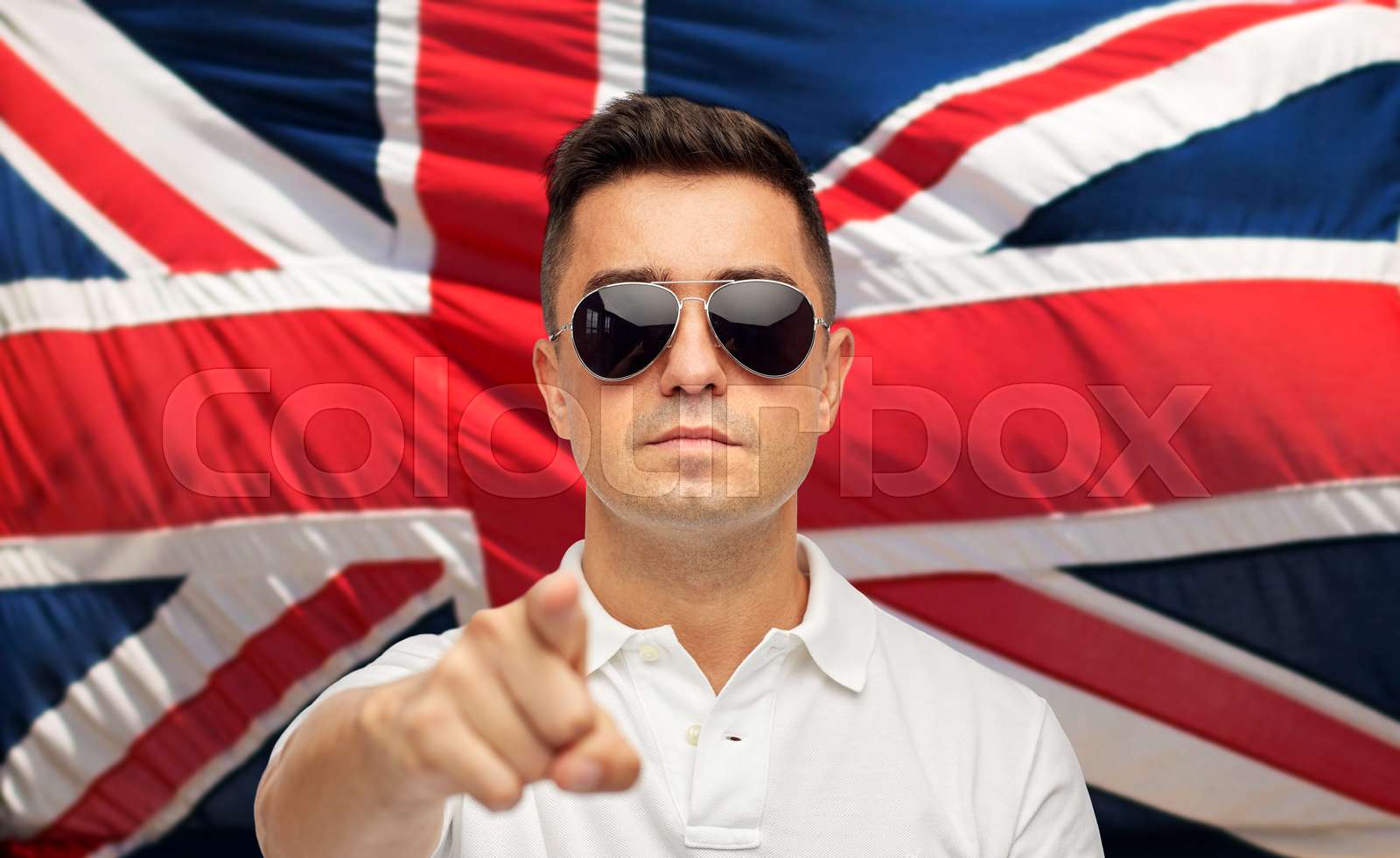 man in shades pointing finger over brittish flag | Stock image | Colourbox