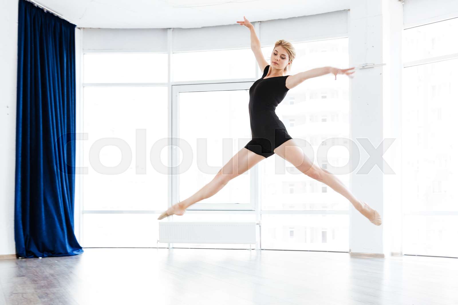Woman ballerina dancing and jumping in ballet studio | Stock image ...