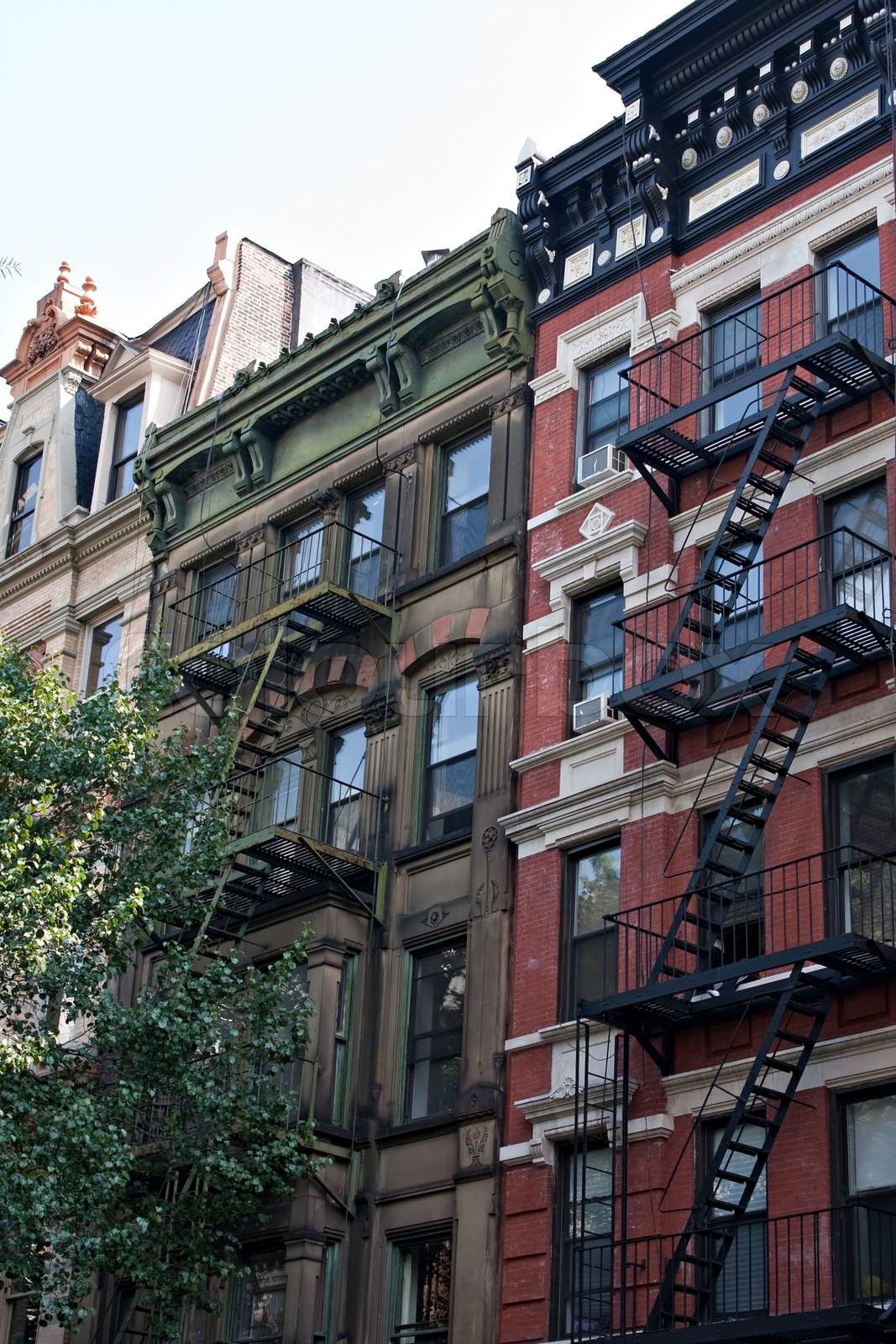Some vintage tenement buildings with iron fire escapes. | Stock image ...