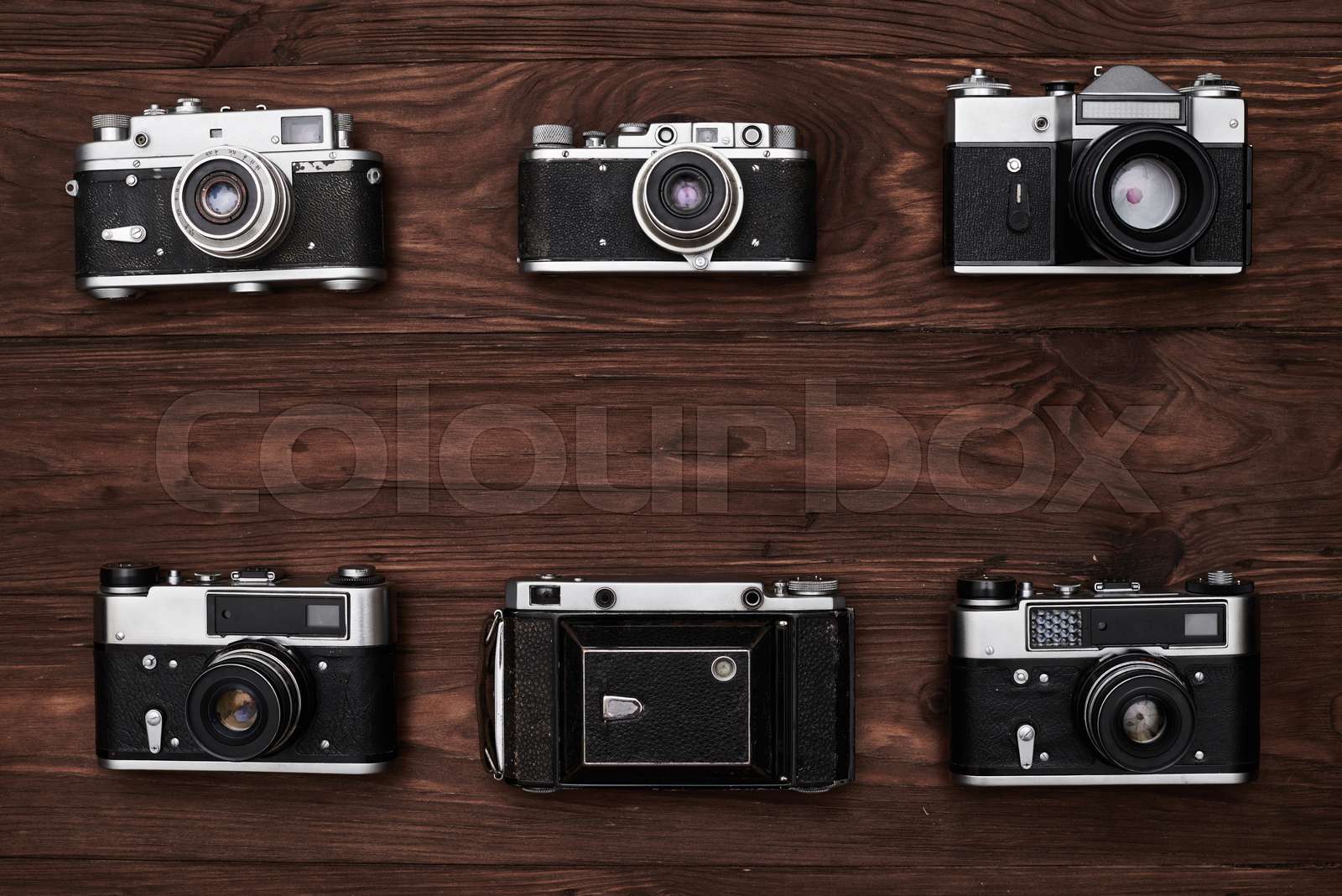 Film cameras lying horizontally on the wooden surface | Stock image ...