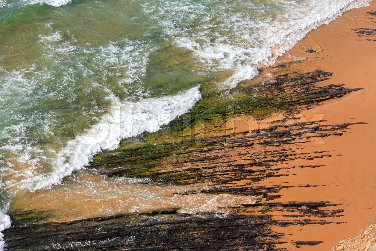Rock formations on beach and surf wave. | Stock image | Colourbox