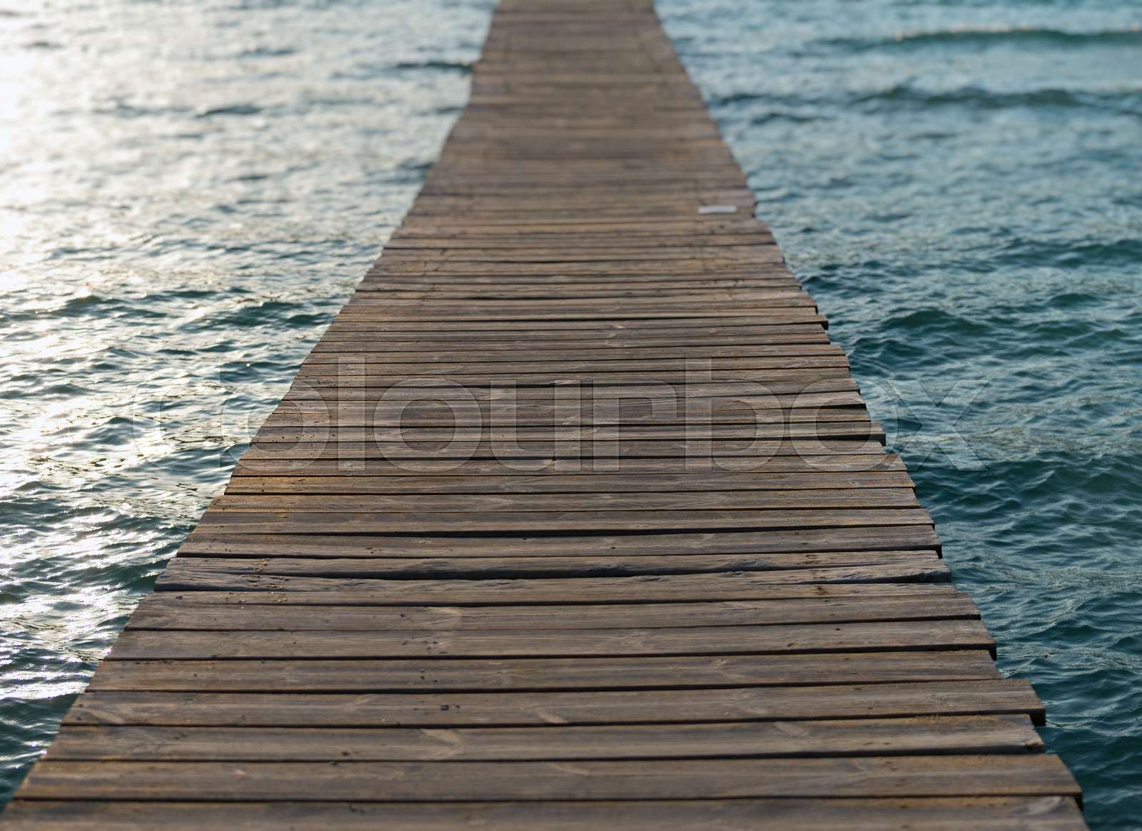 Old wooden pier leading to the sea. | Stock image | Colourbox