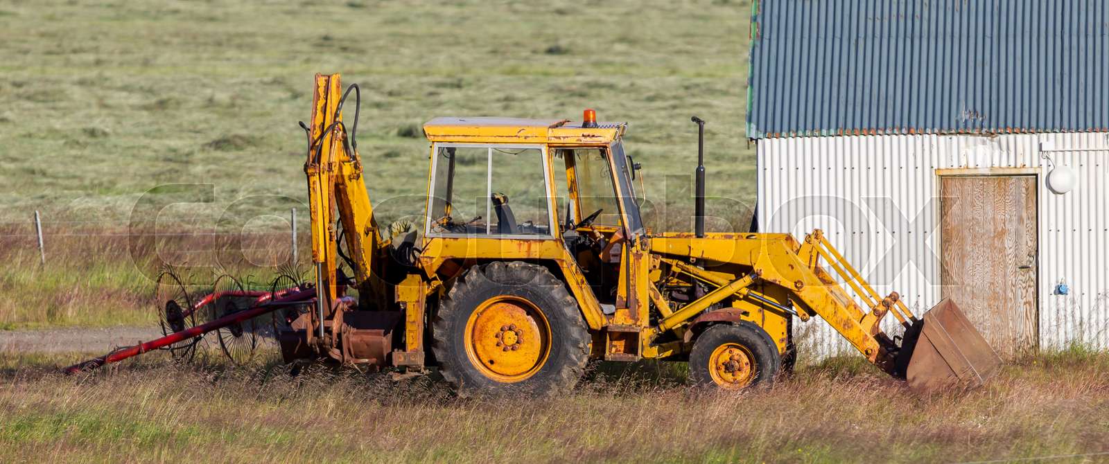 Yellow digger at a farm | Stock image | Colourbox
