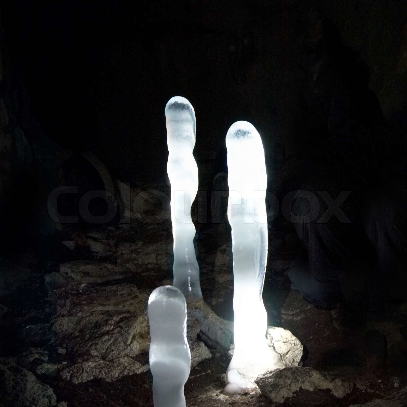 Luminescent ice stalagmites in the cave. | Stock image | Colourbox