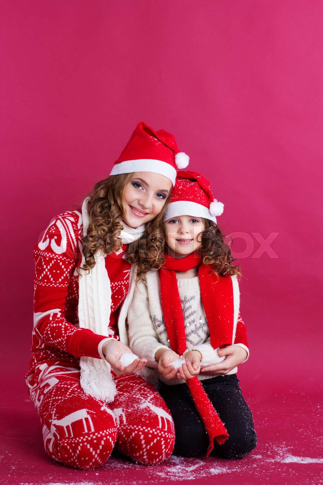 Two girls are wearing winter clothes in studio | Stock image | Colourbox