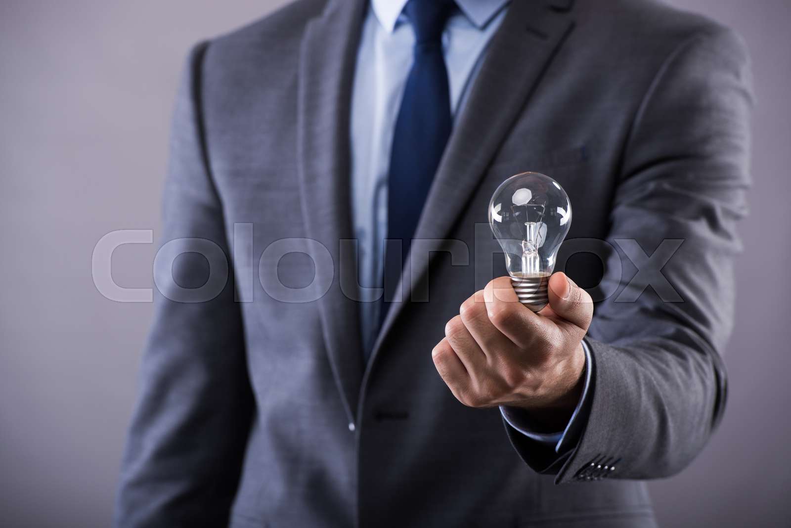 The businessman holding light bulb in creativity concept | Stock image ...