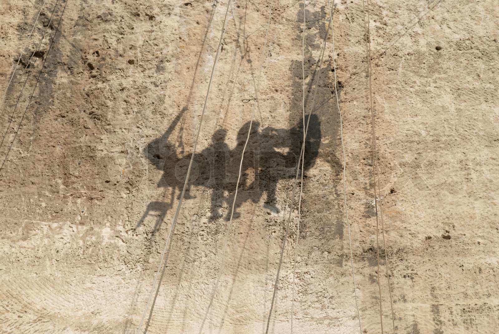 Human shadows on the bright yellow rock | Stock image | Colourbox