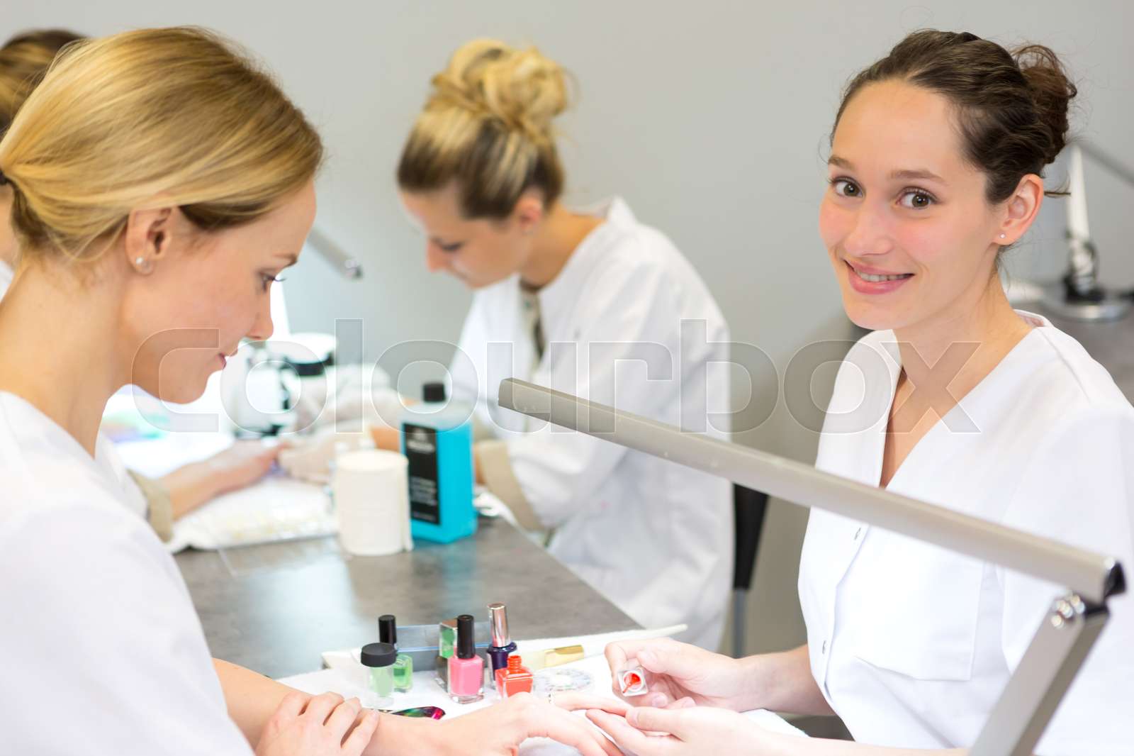 Young attractive beautician students practising during courses | Stock ...