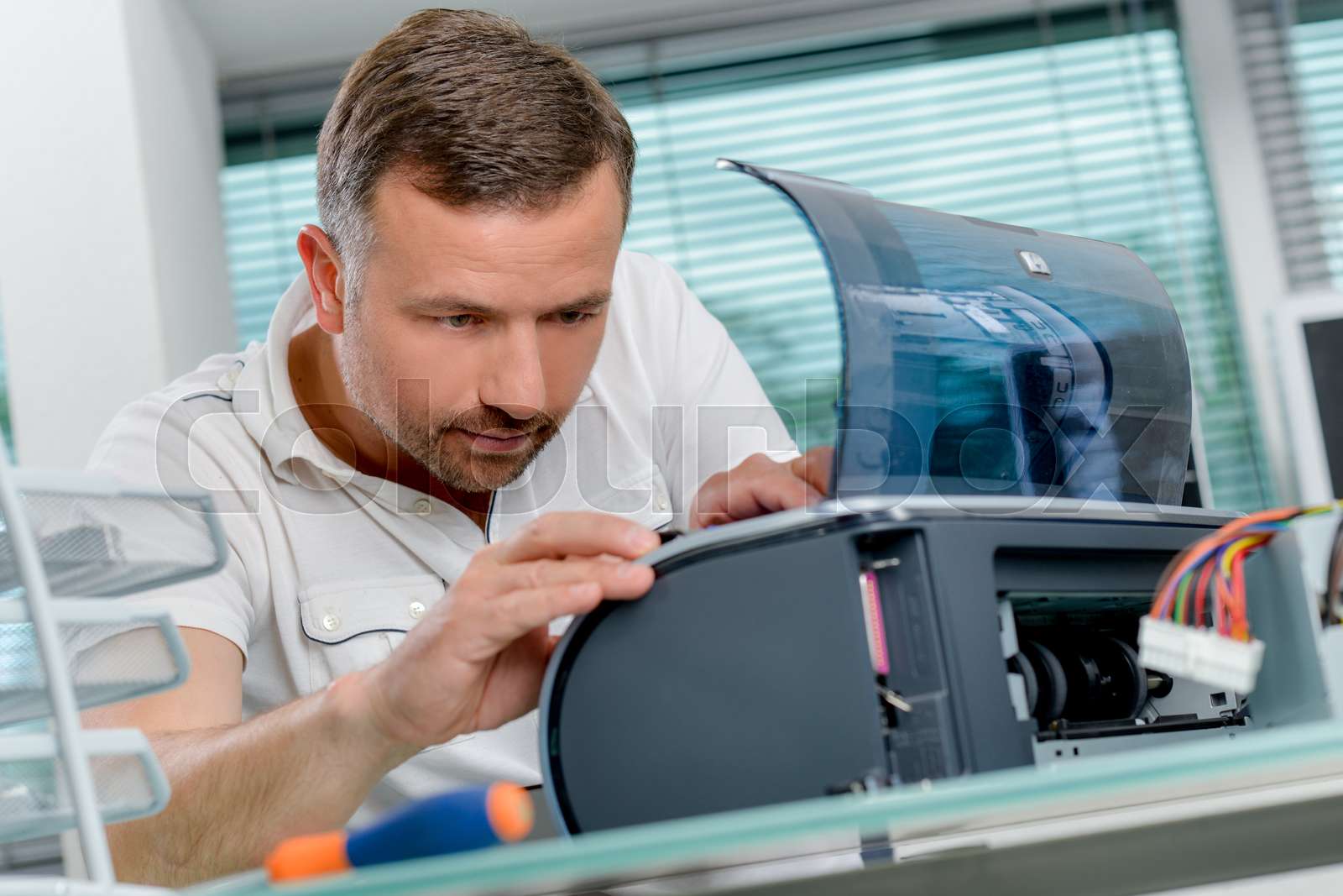 Man repairing printer | Stock image | Colourbox