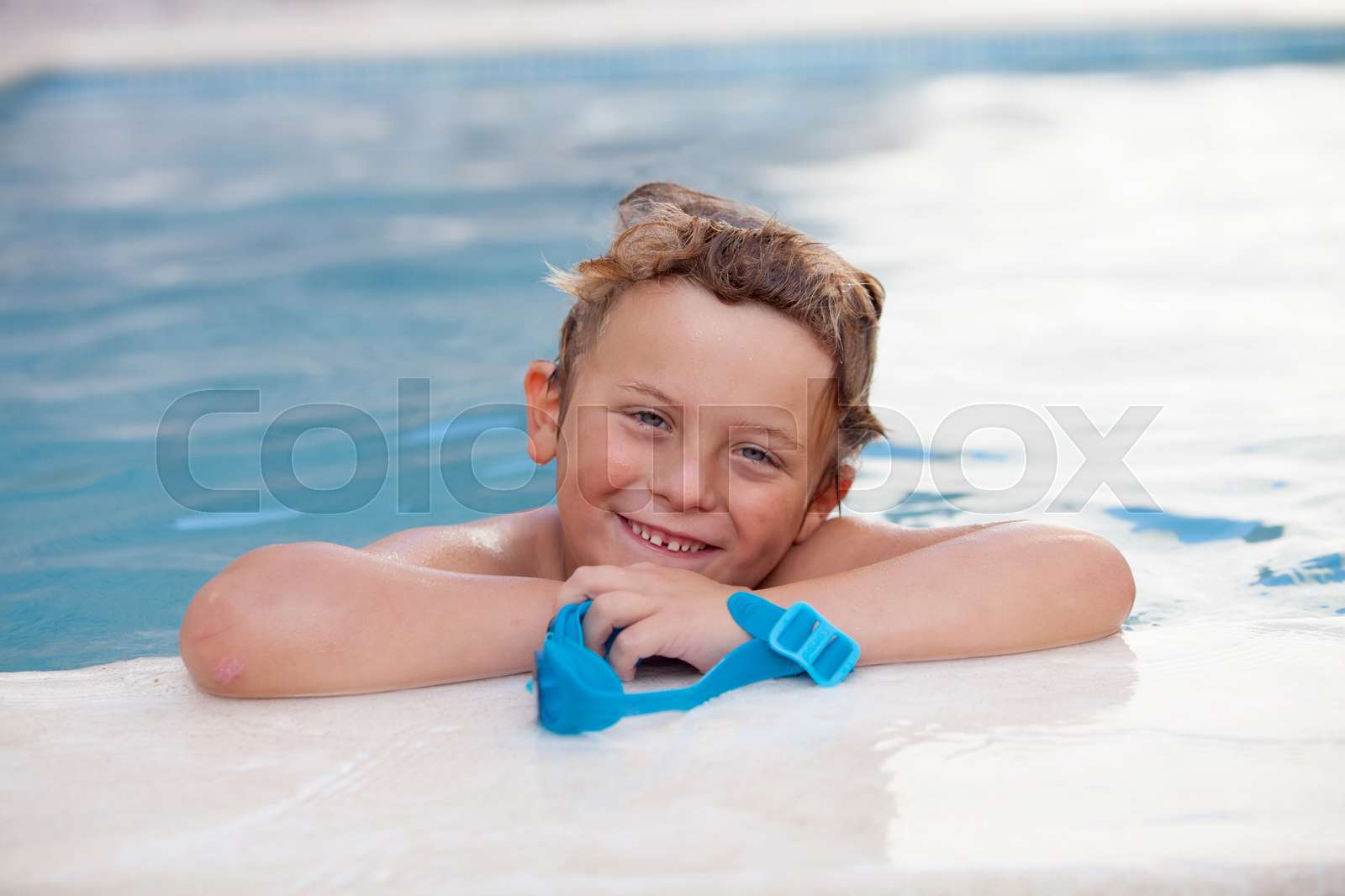 Funny kid cooling off in the pool | Stock image | Colourbox