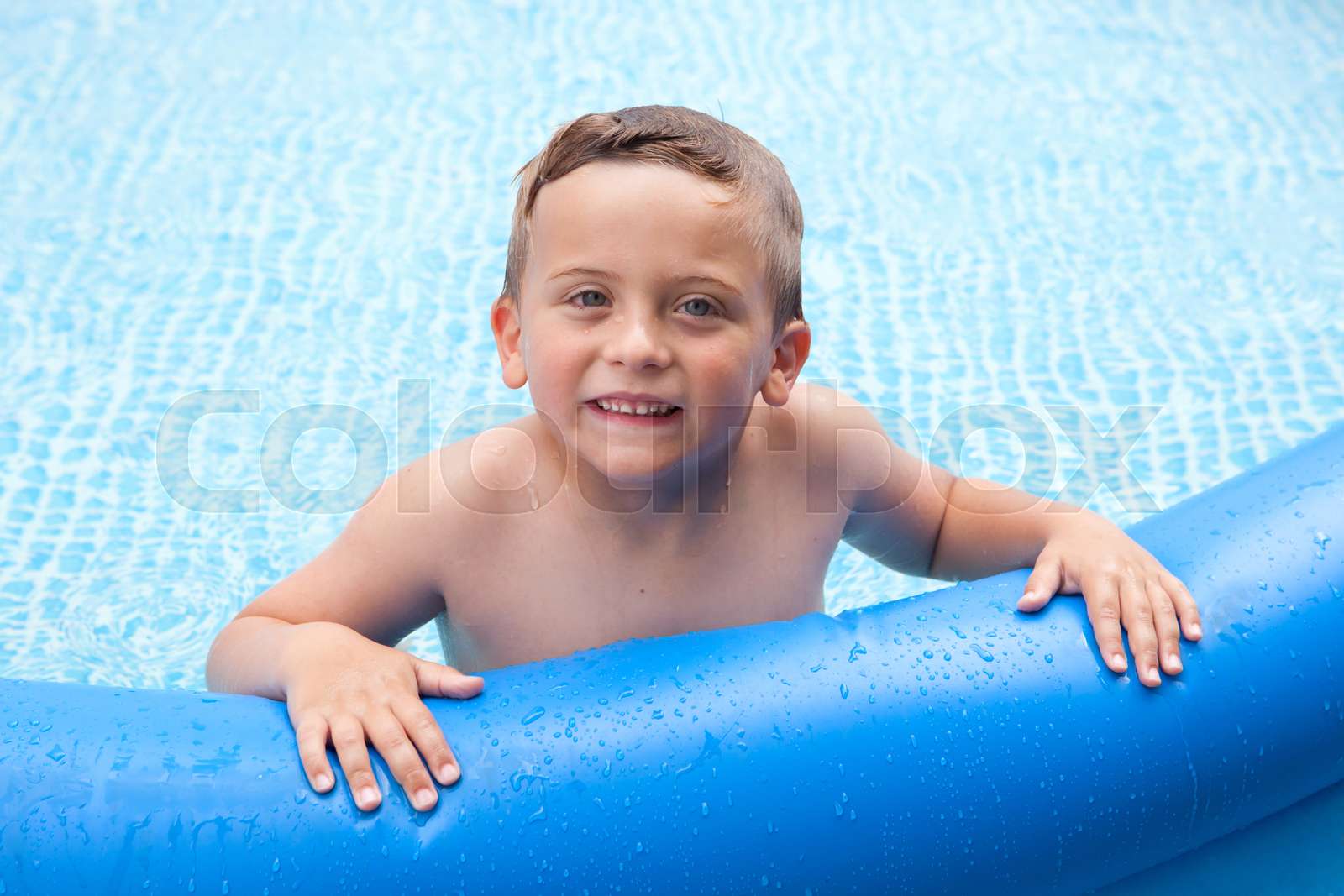 Happy child bathing in the pool | Stock image | Colourbox