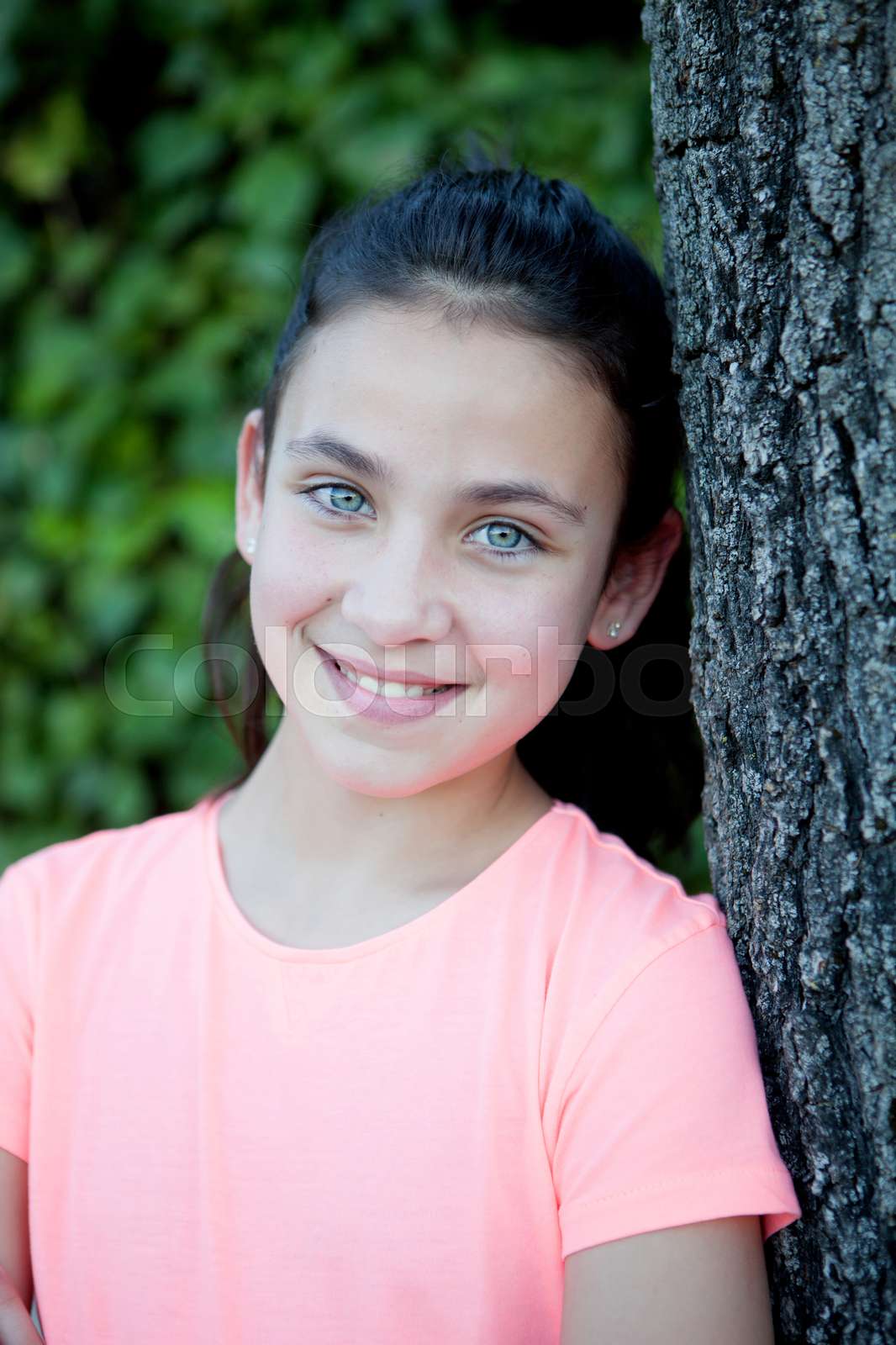 Happy preteen girl with blue eyes smiling | Stock image | Colourbox