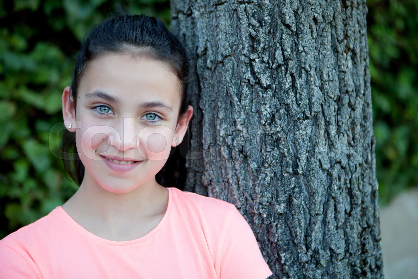Happy preteen girl with blue eyes smiling | Stock image | Colourbox