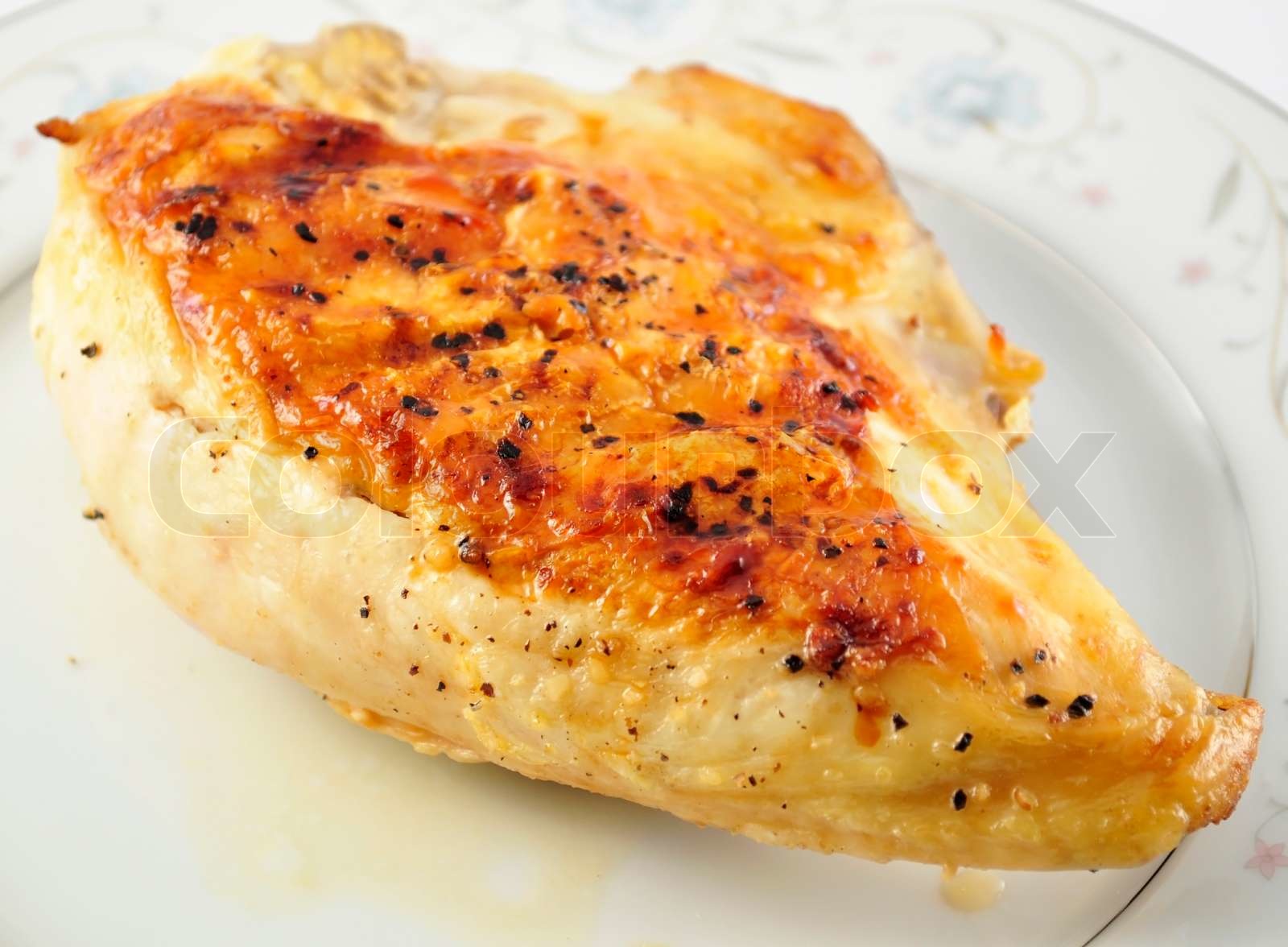 a Grilled chicken breast on a plate , close up | Stock image | Colourbox
