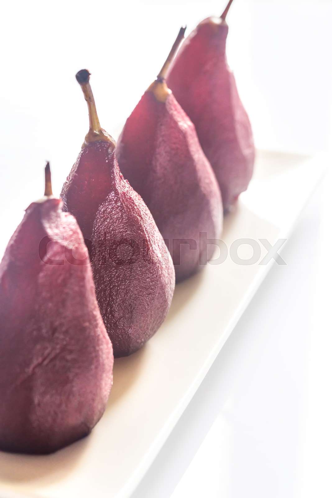 Merlot-poached pears on the plate | Stock image | Colourbox