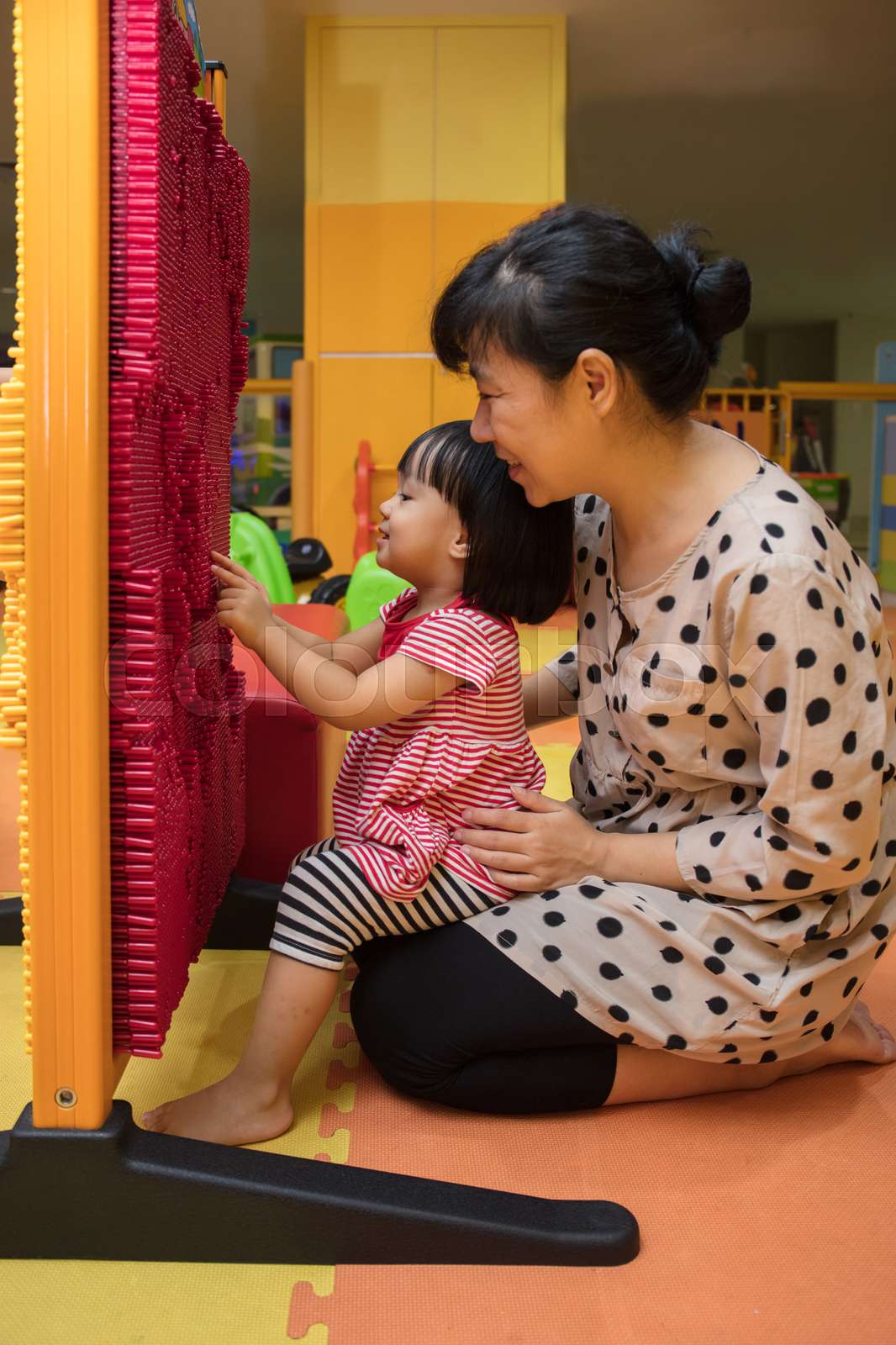 Happy Asian Chinese mom and daughter playing pin board | Stock image ...