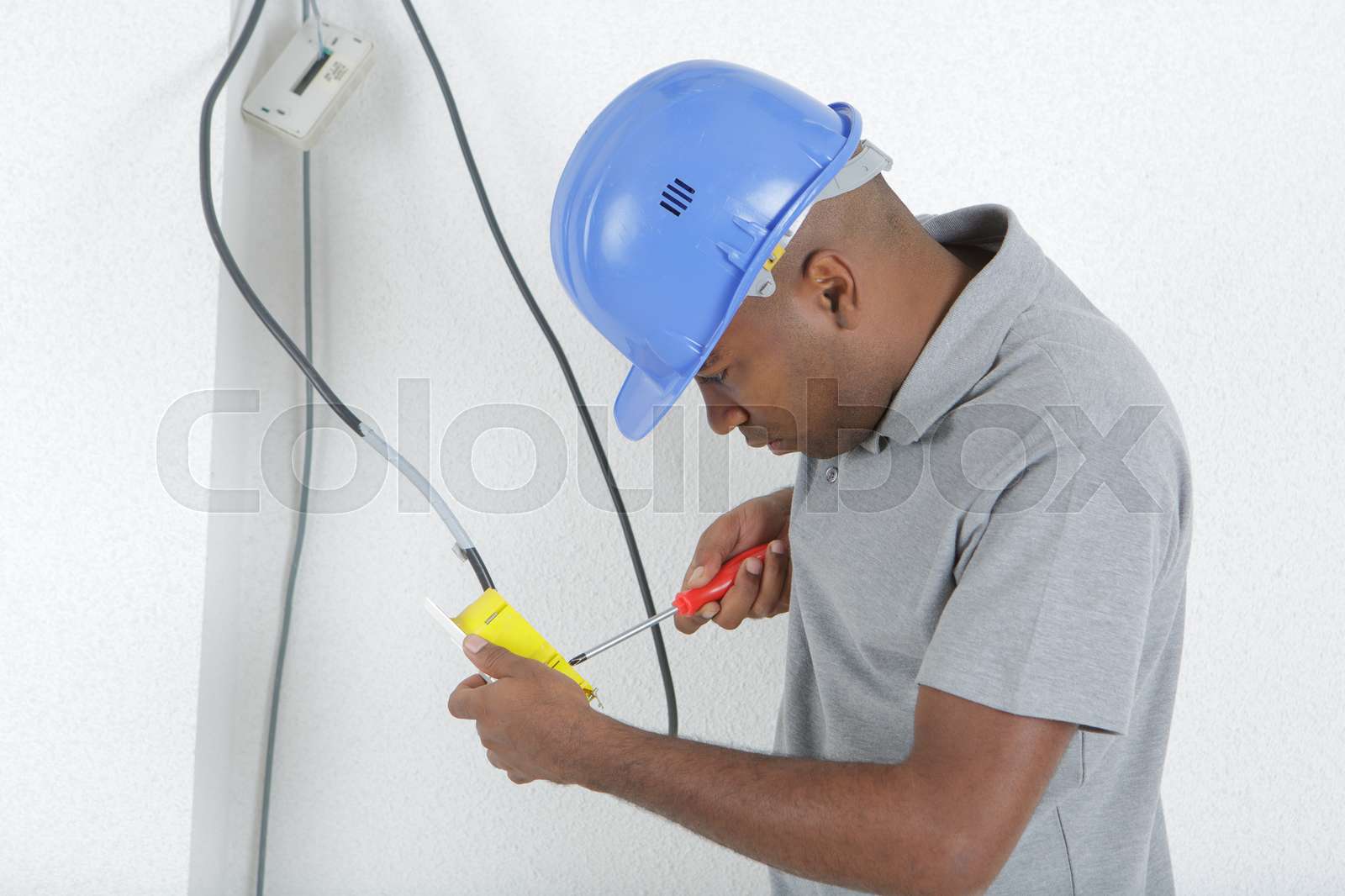 electrician fixing a wire | Stock image | Colourbox