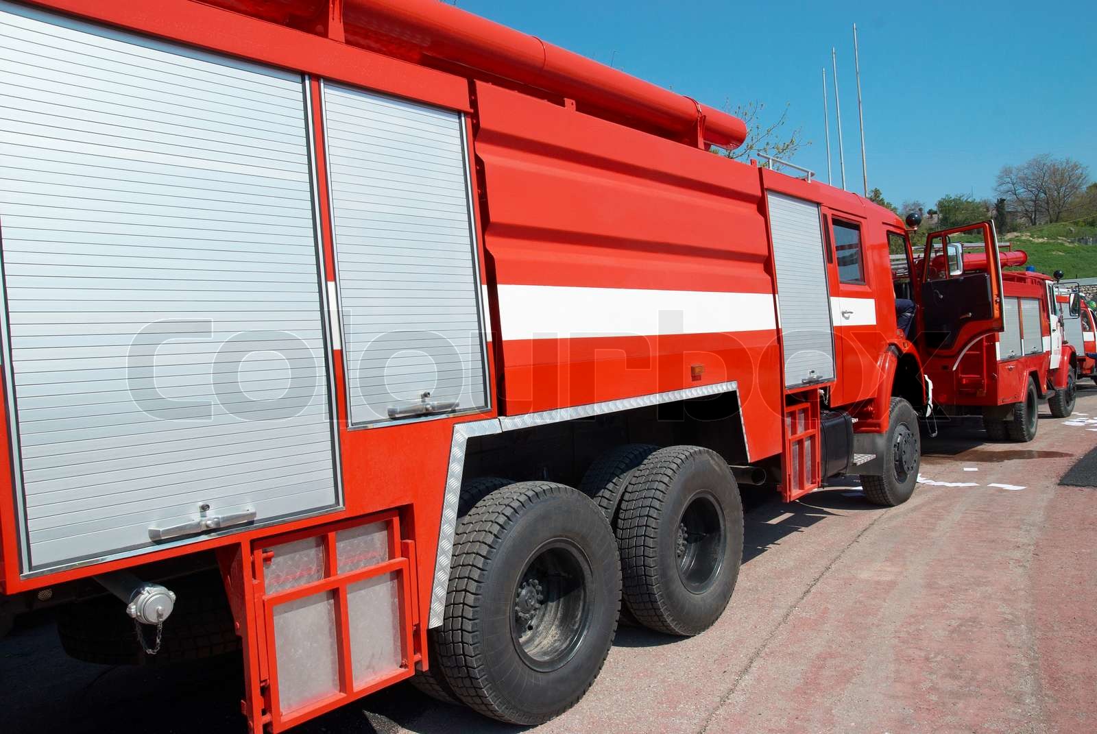 Red fire engine standing on the road | Stock image | Colourbox