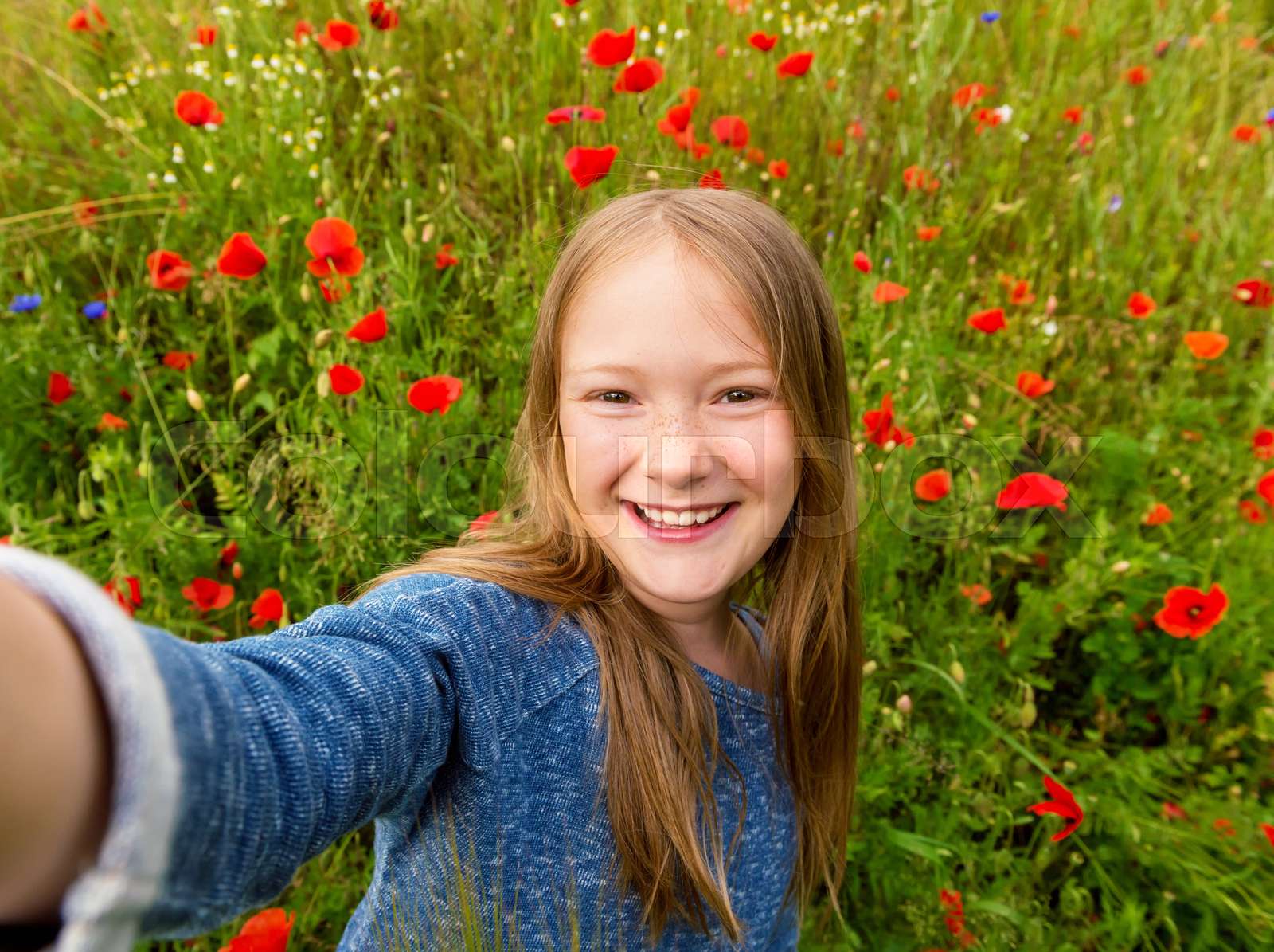 funny-little-girl-doing-selfie-in-poppy-field-preteen-8-9-years-old