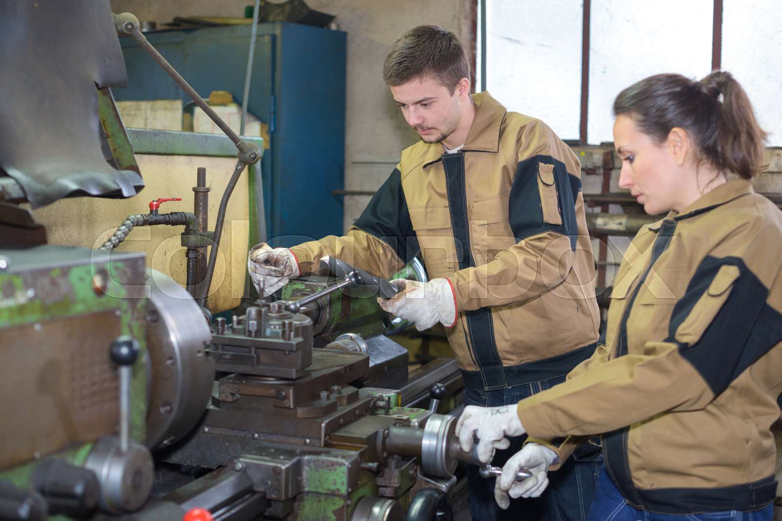 employees using industrial machinery at factory | Stock image | Colourbox