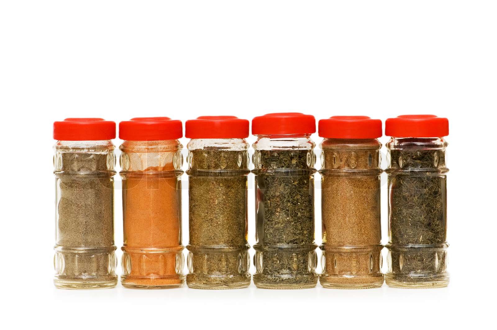 Forskellige krydderier i flasker isoleret på hvidt | Stock foto | Colourbox