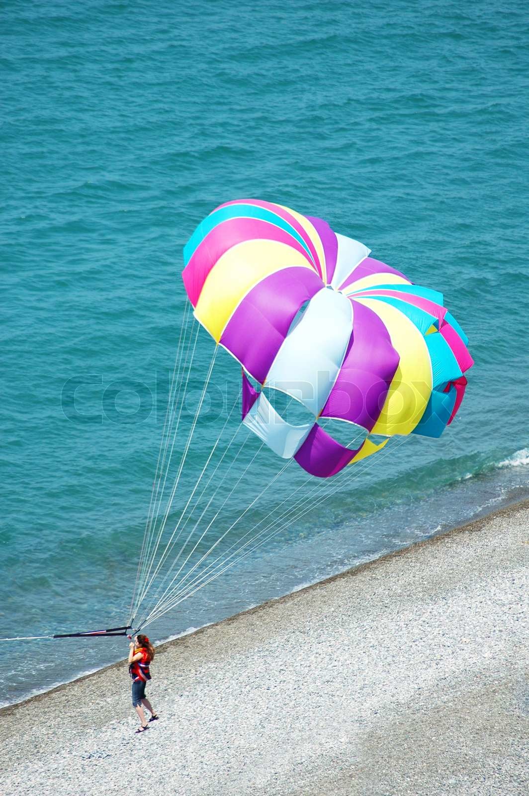 Multi coloured parachute over the blue sea | Stock image | Colourbox