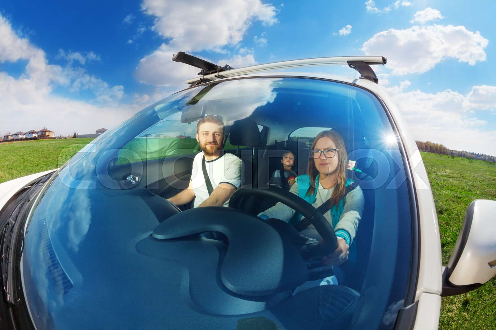 Young mother driving car with her family | Stock image | Colourbox