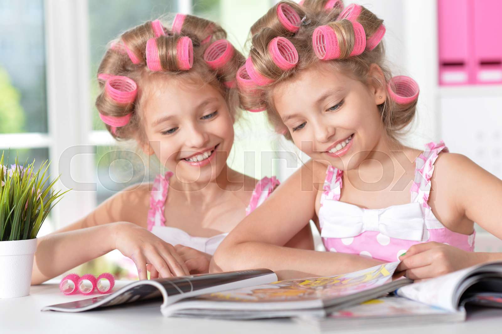 tweenie girls in hair curlers with magazine | Stock image | Colourbox
