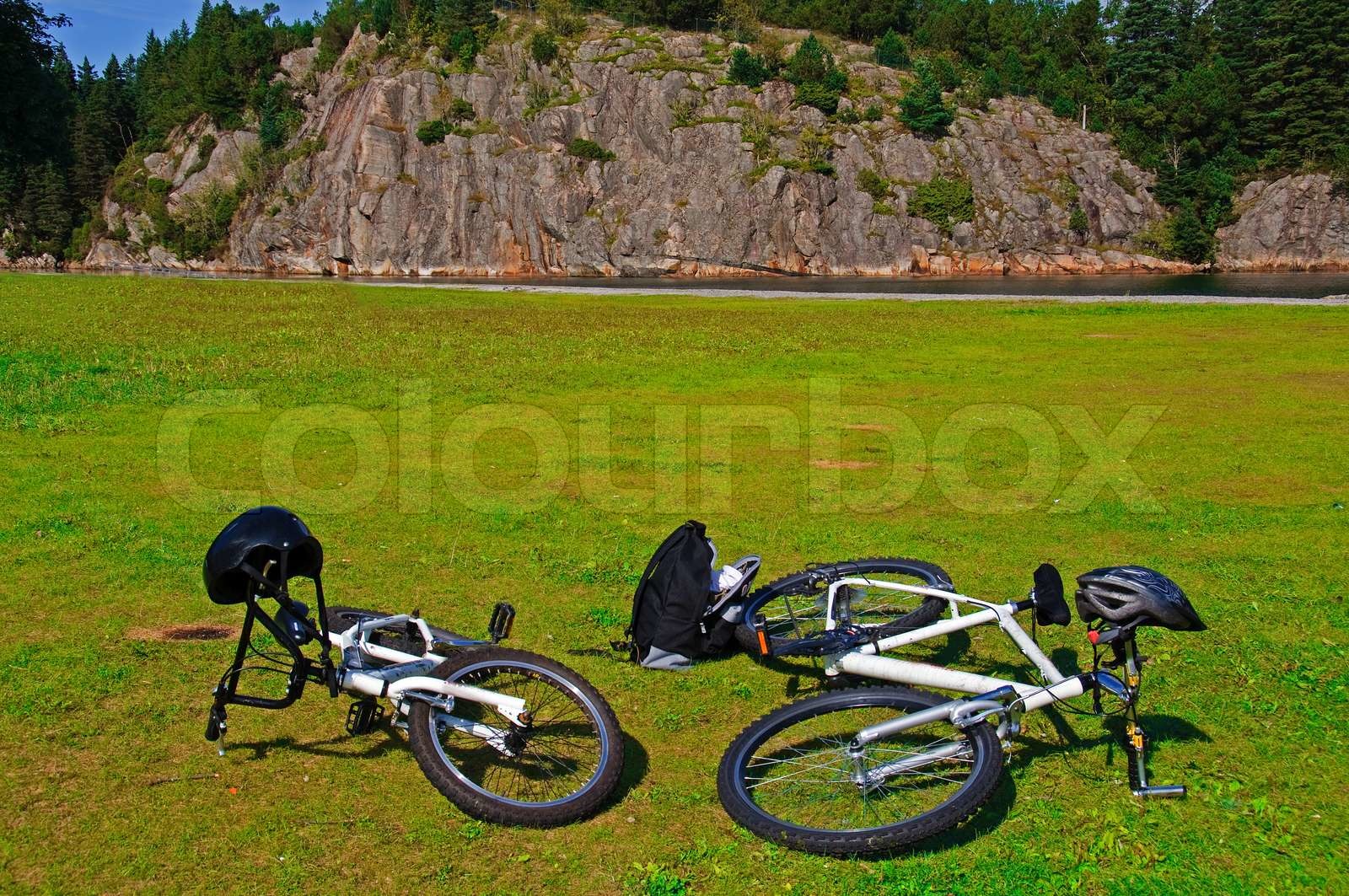 Two bicycles lying on the grass | Stock image | Colourbox
